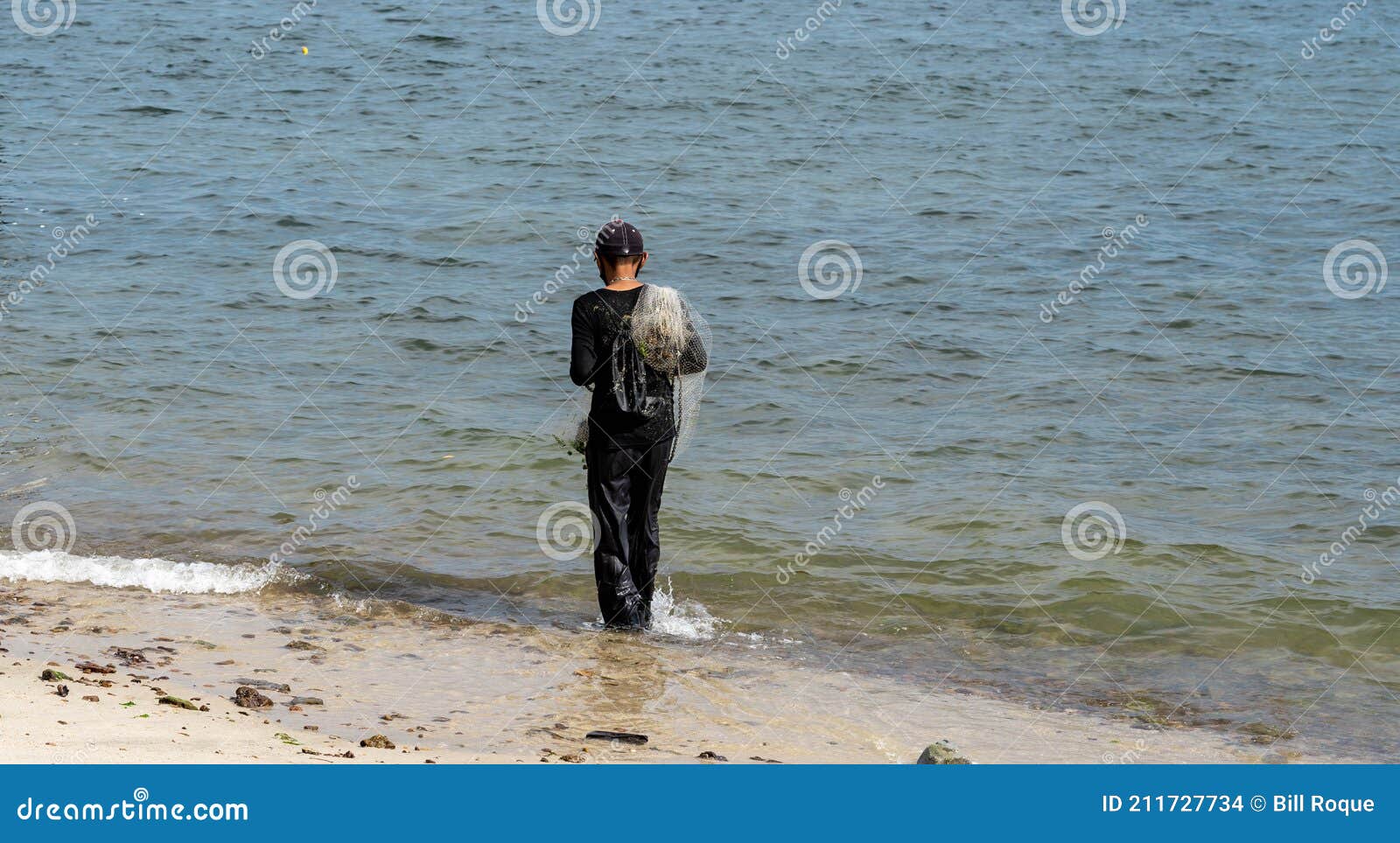 Fisherman Walking on a Beach Carrying a Net on His Shoulder Editorial ...