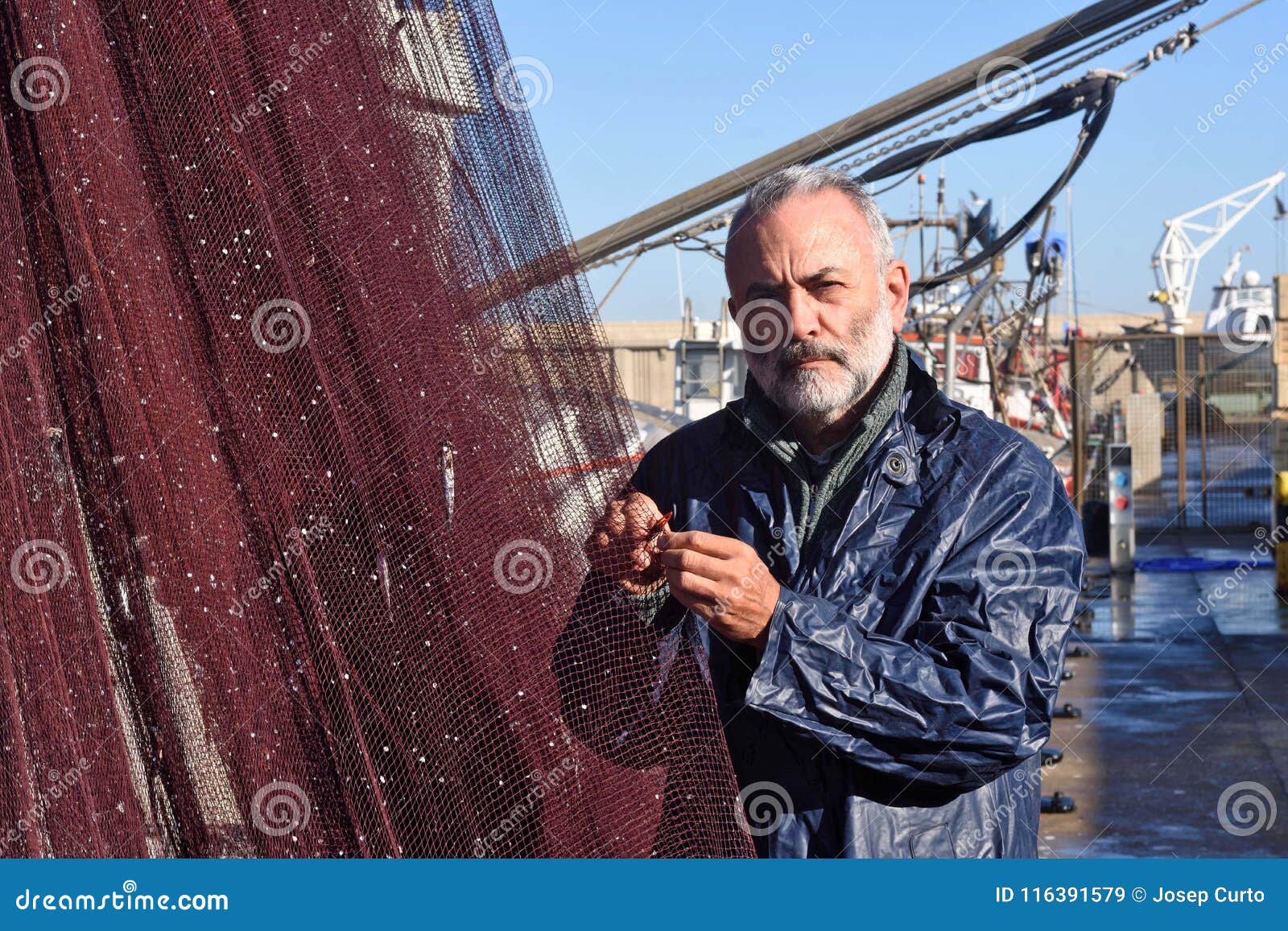 A Fisherman Working in the Sea Stock Image - Image of looking, blue ...