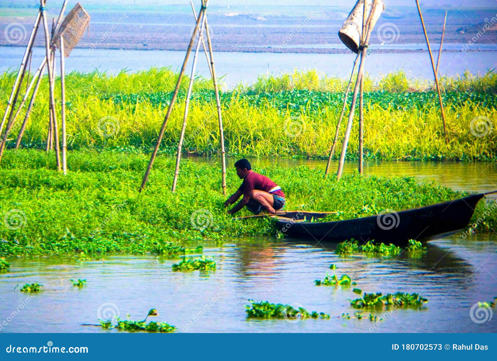 Indian Waterman Standing In The Front Of Boat And See The Varanasi ...