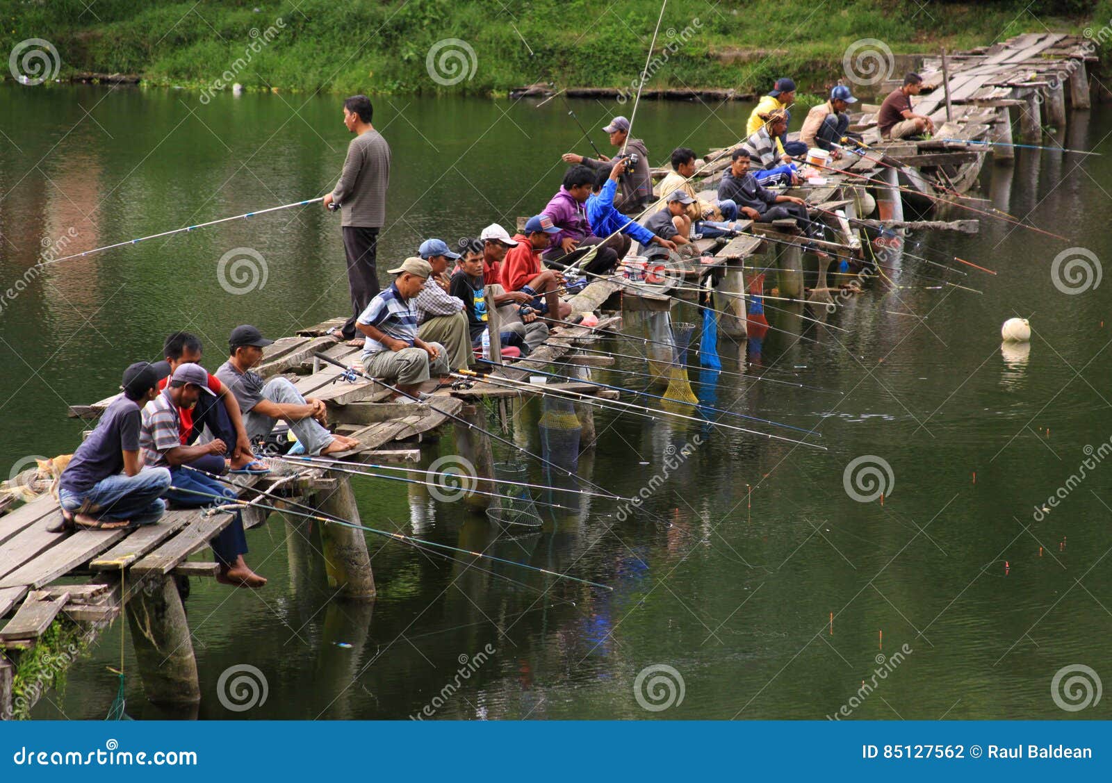 Fishermen crowd the bridge editorial photography. Image of bridge ...