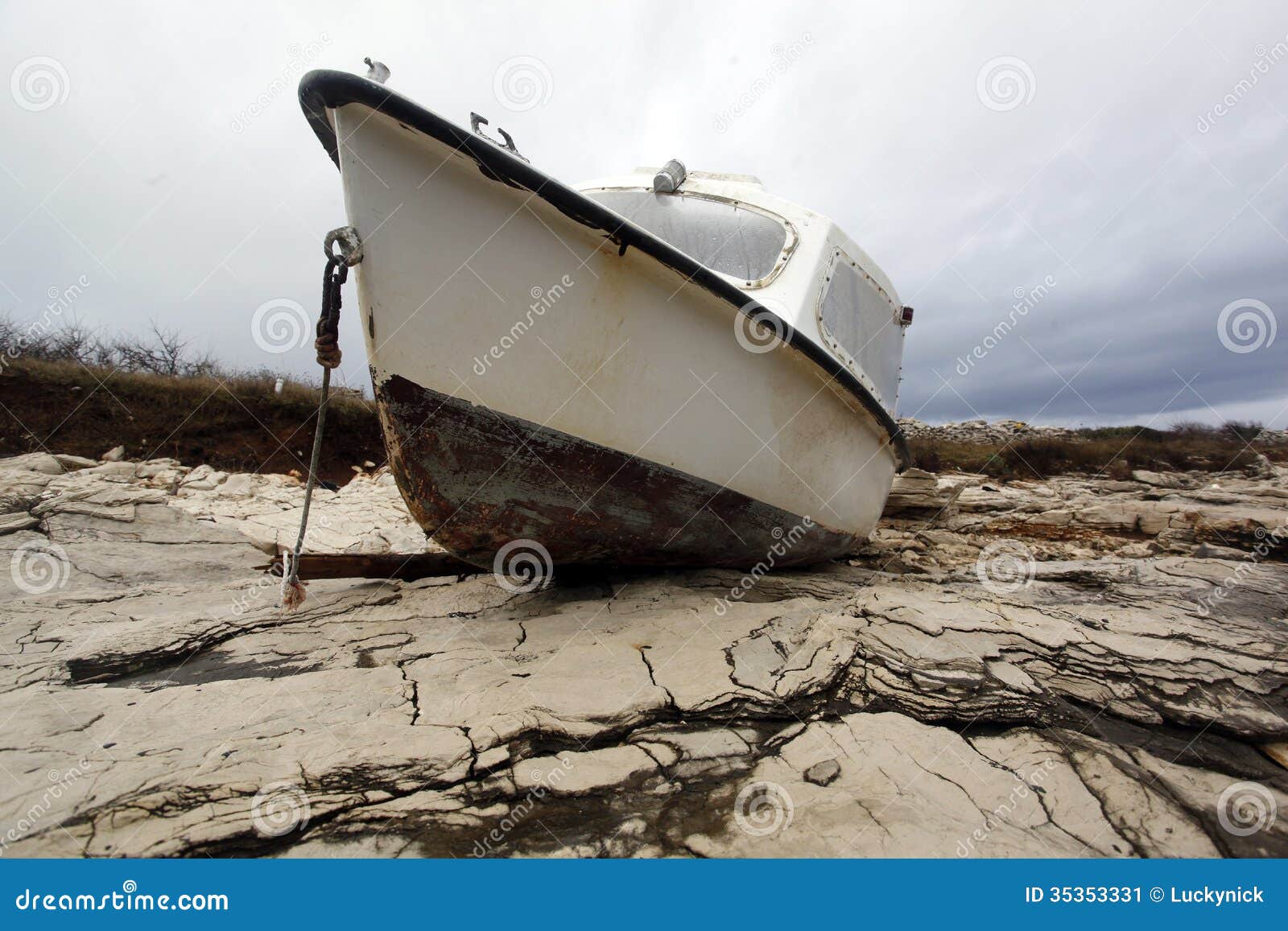 Fishing Boat Beached on a Rock Stock Image - Image of cracked, thrown ...