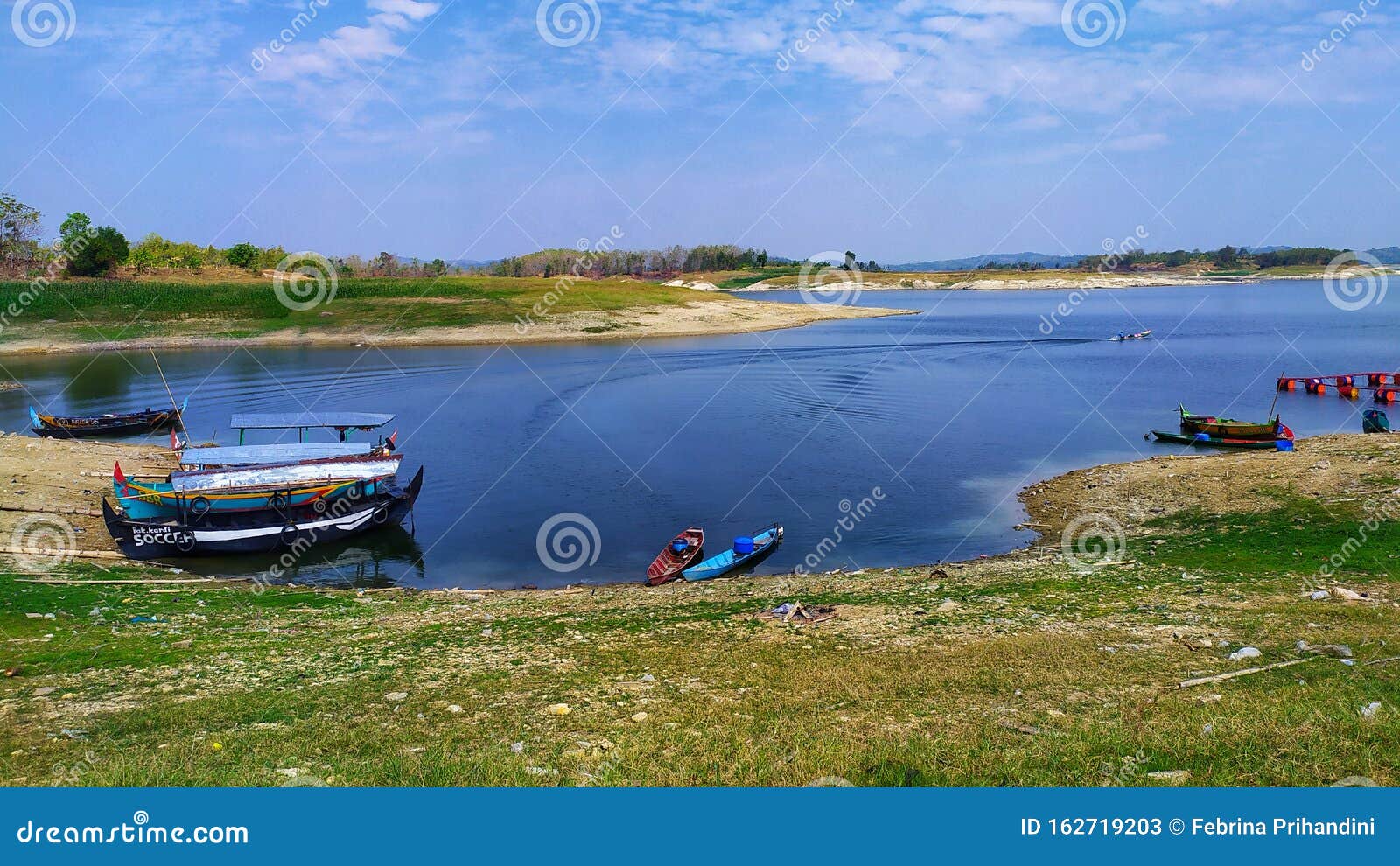 Fishing Boat on the Edge of the Lake with Blue Sky Stock Image - Image ...