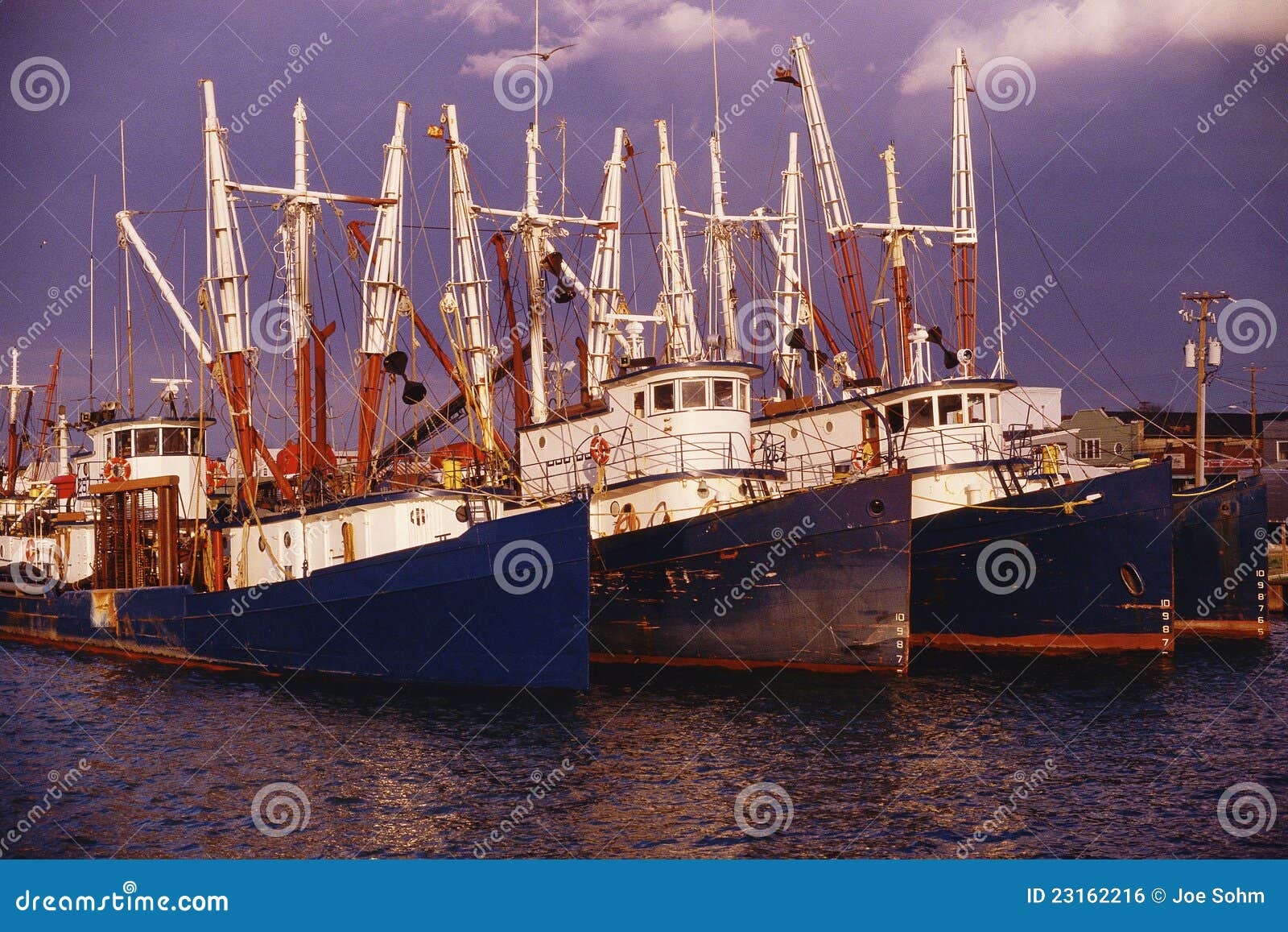 Fishing boats in harbor stock photo. Image of sunset - 23162216