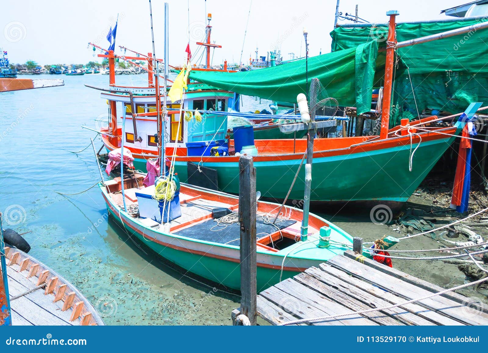 Fishing boats at the shore stock photo. Image of harbor - 113529170