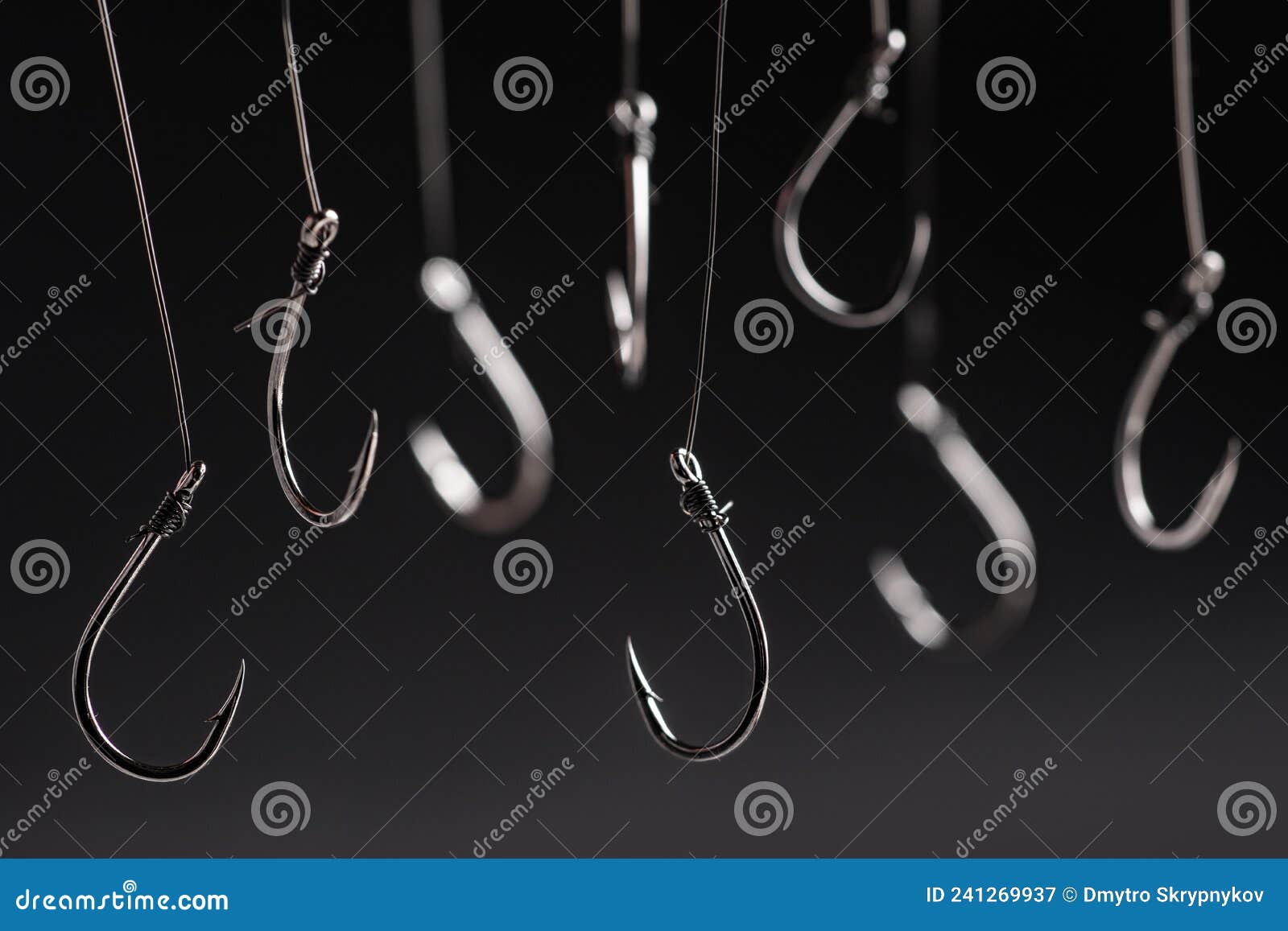 A Fishing Hooks Hanging on a Fishing Line on a Black Background Stock ...