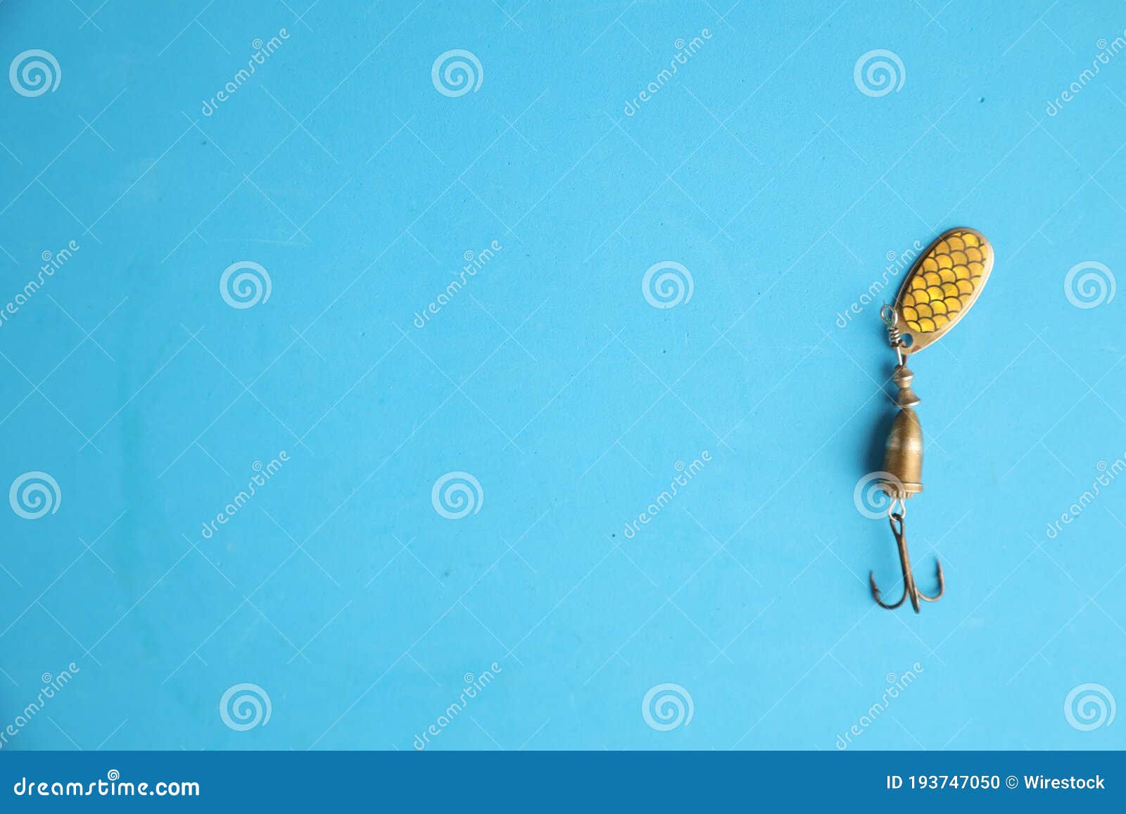 Fishing Lure Isolated on a Blue Background Stock Photo - Image of tools ...