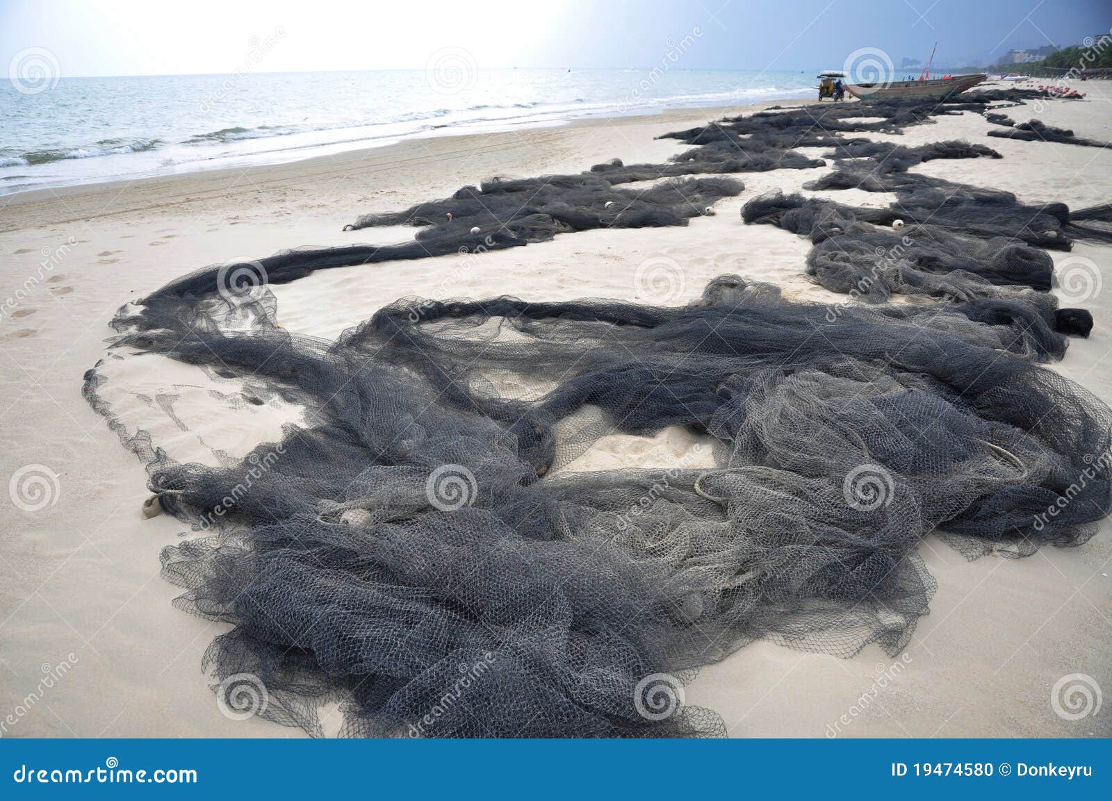 Fishing net on sand beach stock photo. Image of fishery - 19474580