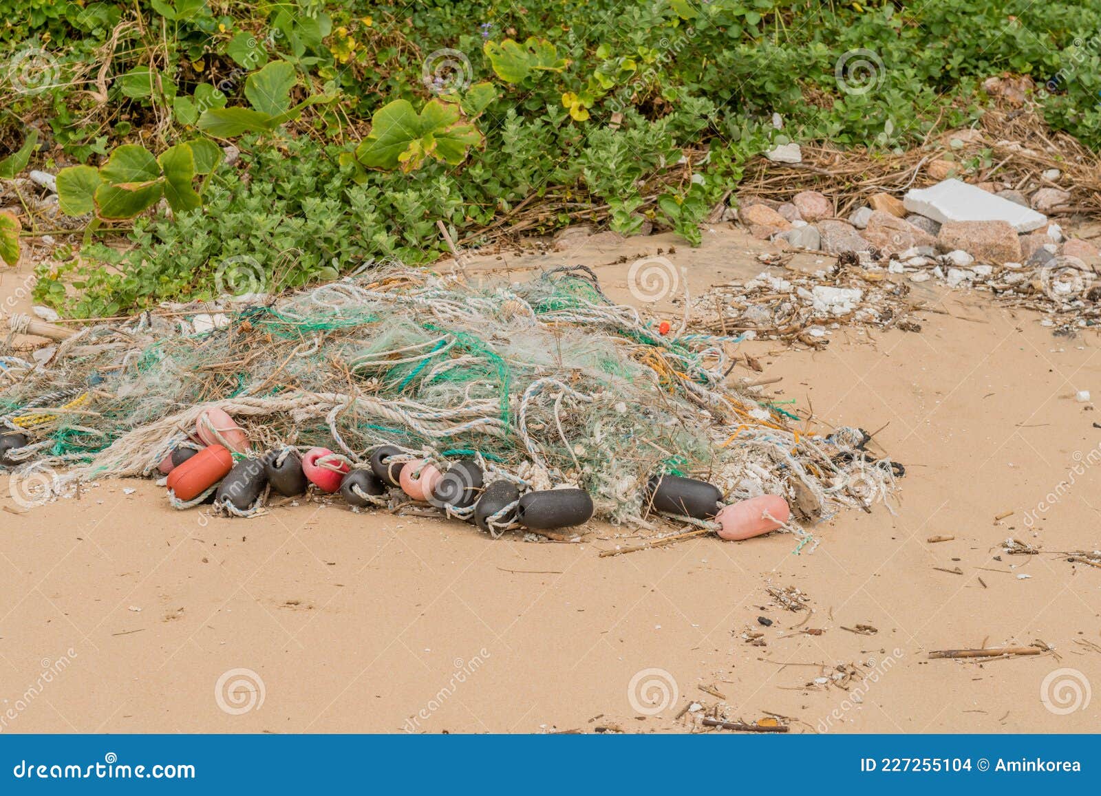 Fishing Nets and Debris Left Laying on Beach Stock Photo - Image of ...