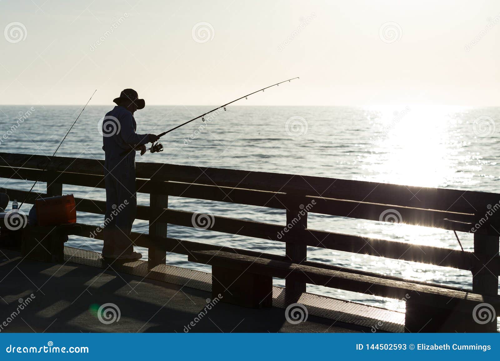 Fishing Off a Pier Silhouette at Sunset Stock Image - Image of orange ...