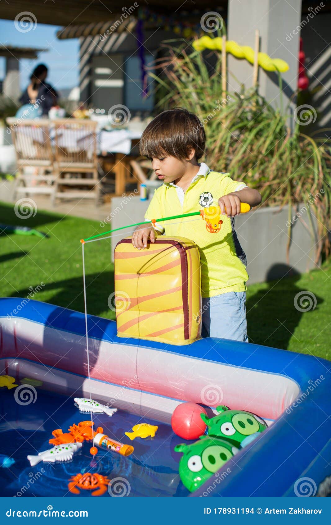 Fishing in the Paddling Pool. the Children are Playing. Stock Photo ...