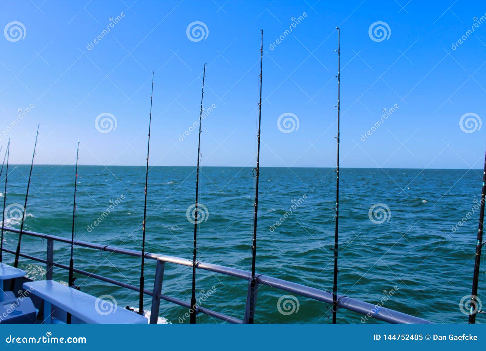 Fishing poles on the ocean stock image. Image of waves - 144752405