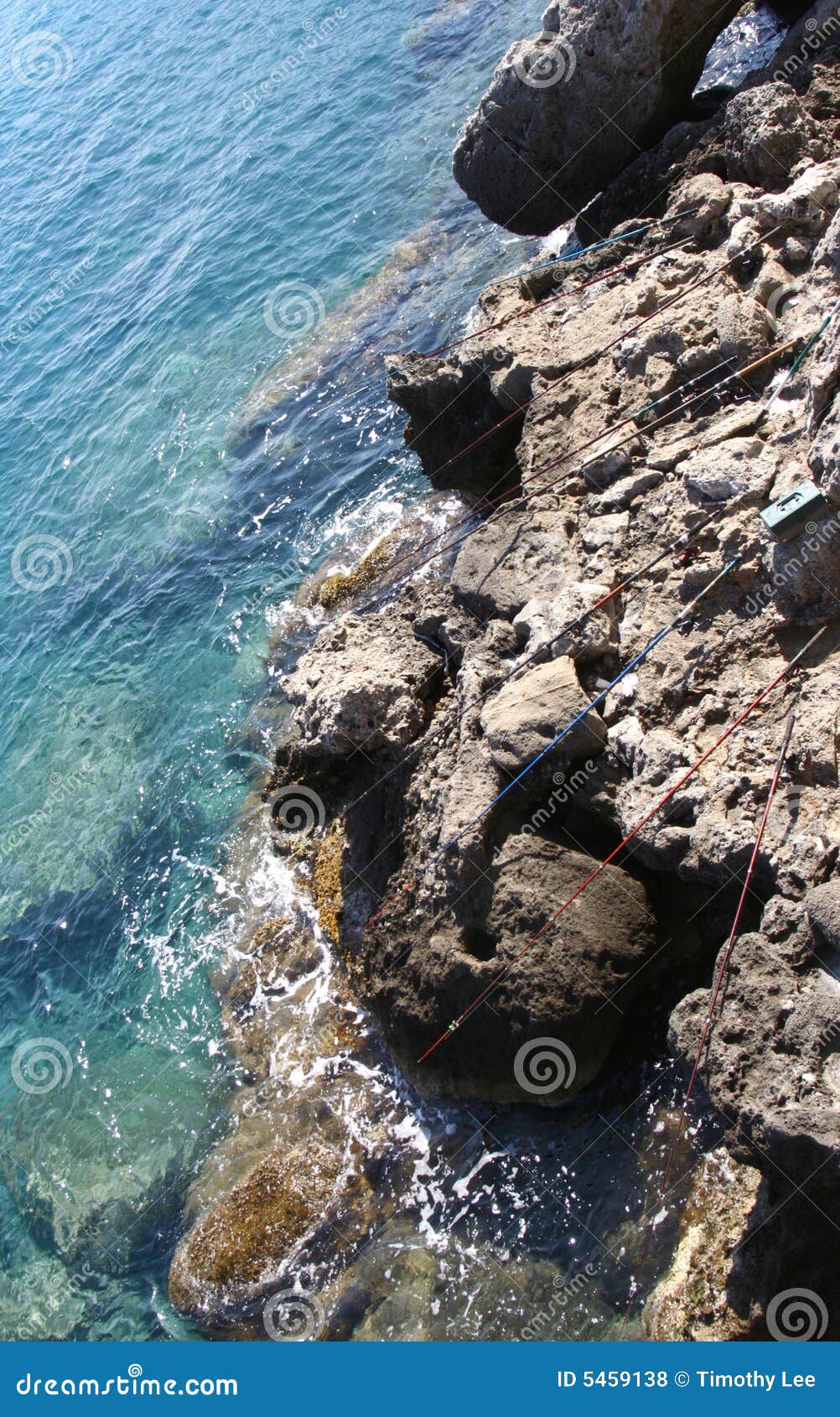 Fishing poles on rocks stock photo. Image of pole, fishing - 5459138