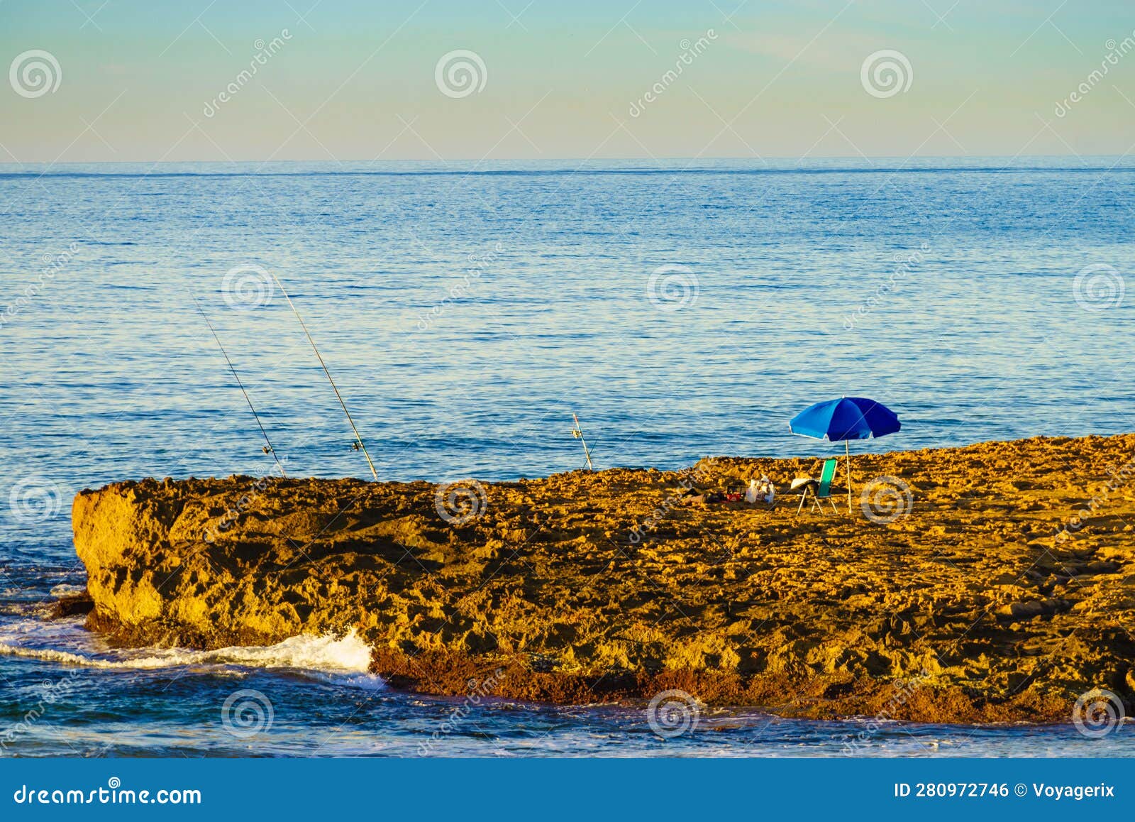 Fishing poles at sea shore stock photo. Image of leisure - 280972746