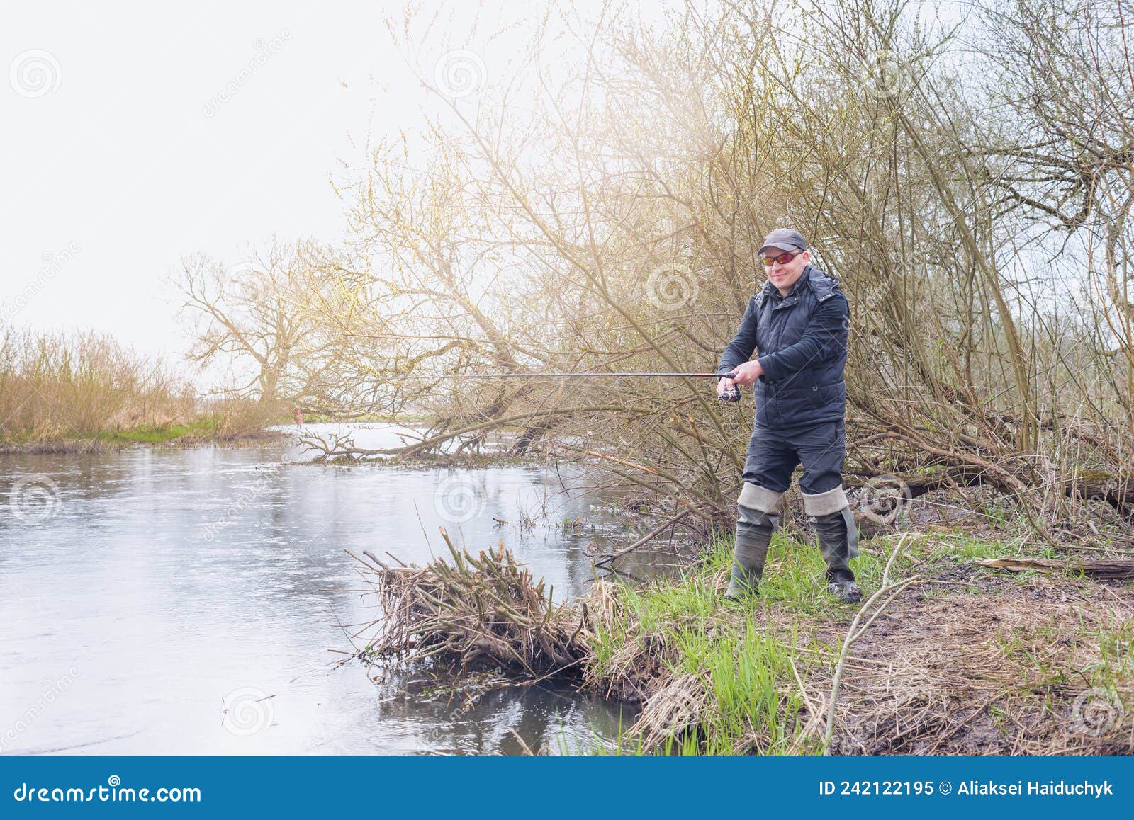 Fishing on the river bank stock image. Image of lake - 242122195