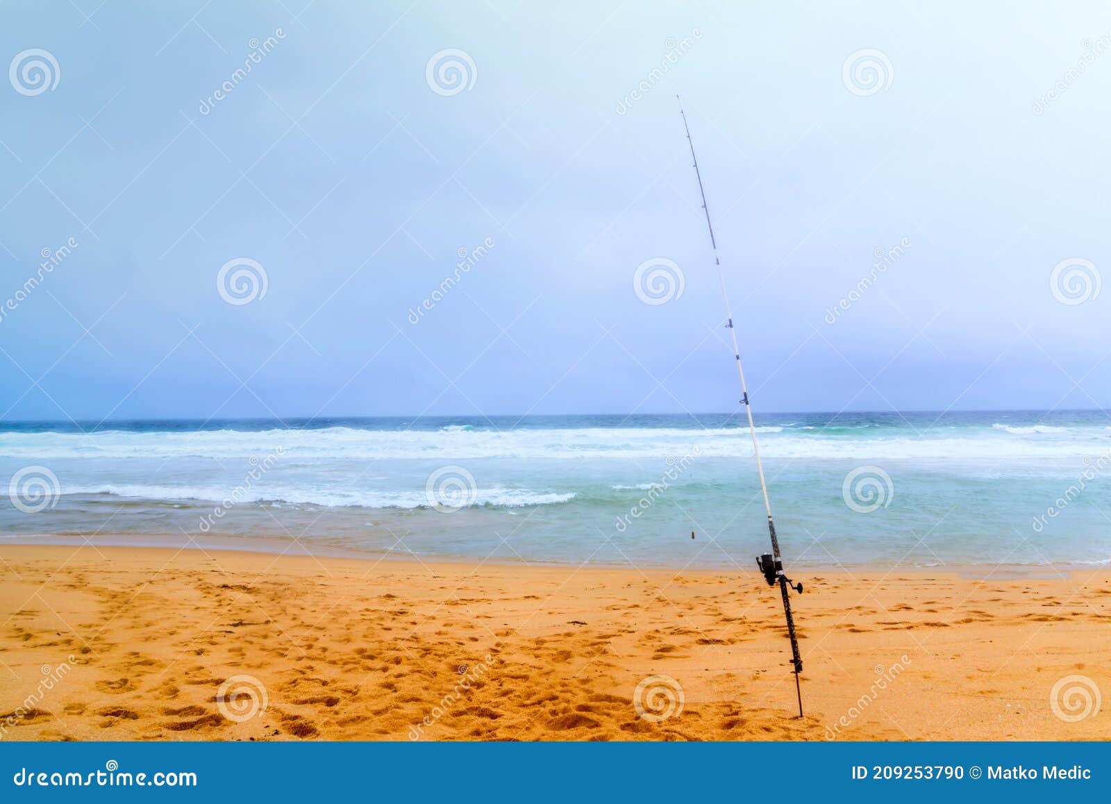 Fishing rod at the beach stock photo. Image of ocean - 209253790