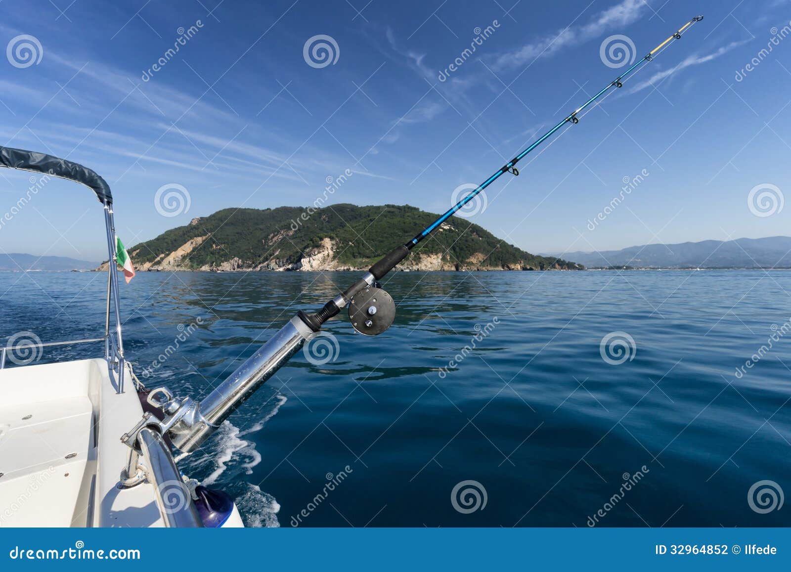 Fishing Rod on Boat with Island in Background Stock Photo - Image of ...