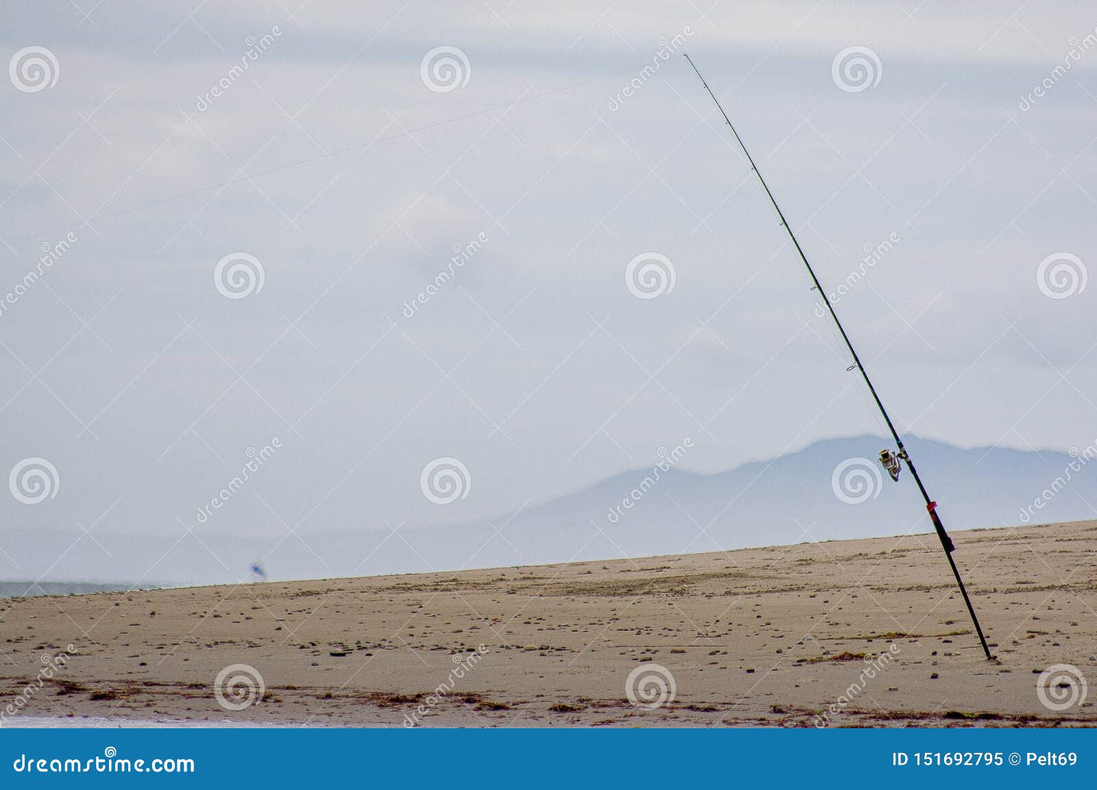 Fishing Rod in the Sand stock image. Image of ocean - 151692795