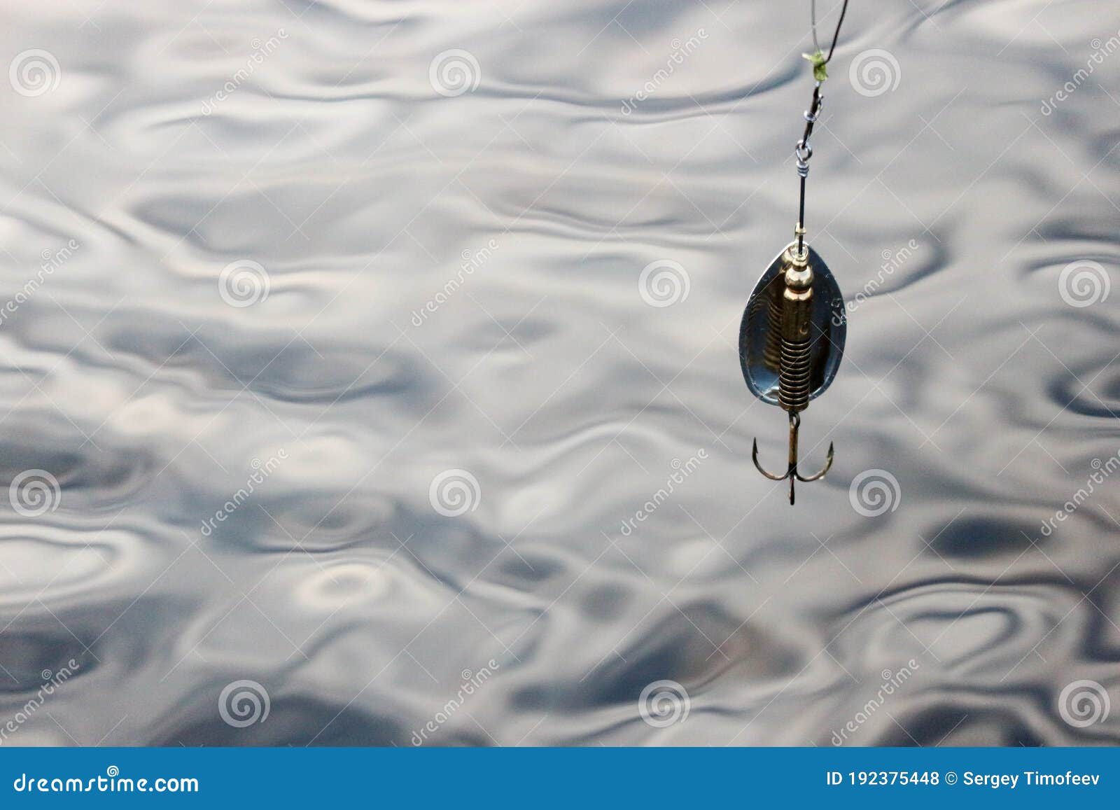 Fishing Spoon with a Hook on Water Background with Reflection Stock ...