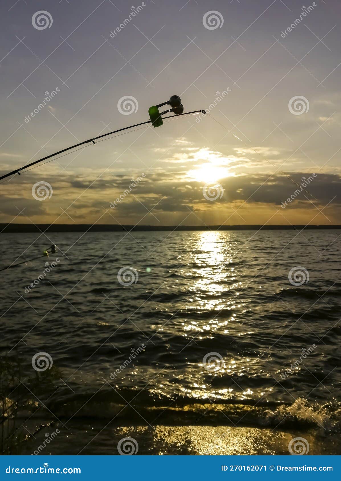 Fishing at Sunset. One Fishing Rod Against the Backdrop of the Setting ...