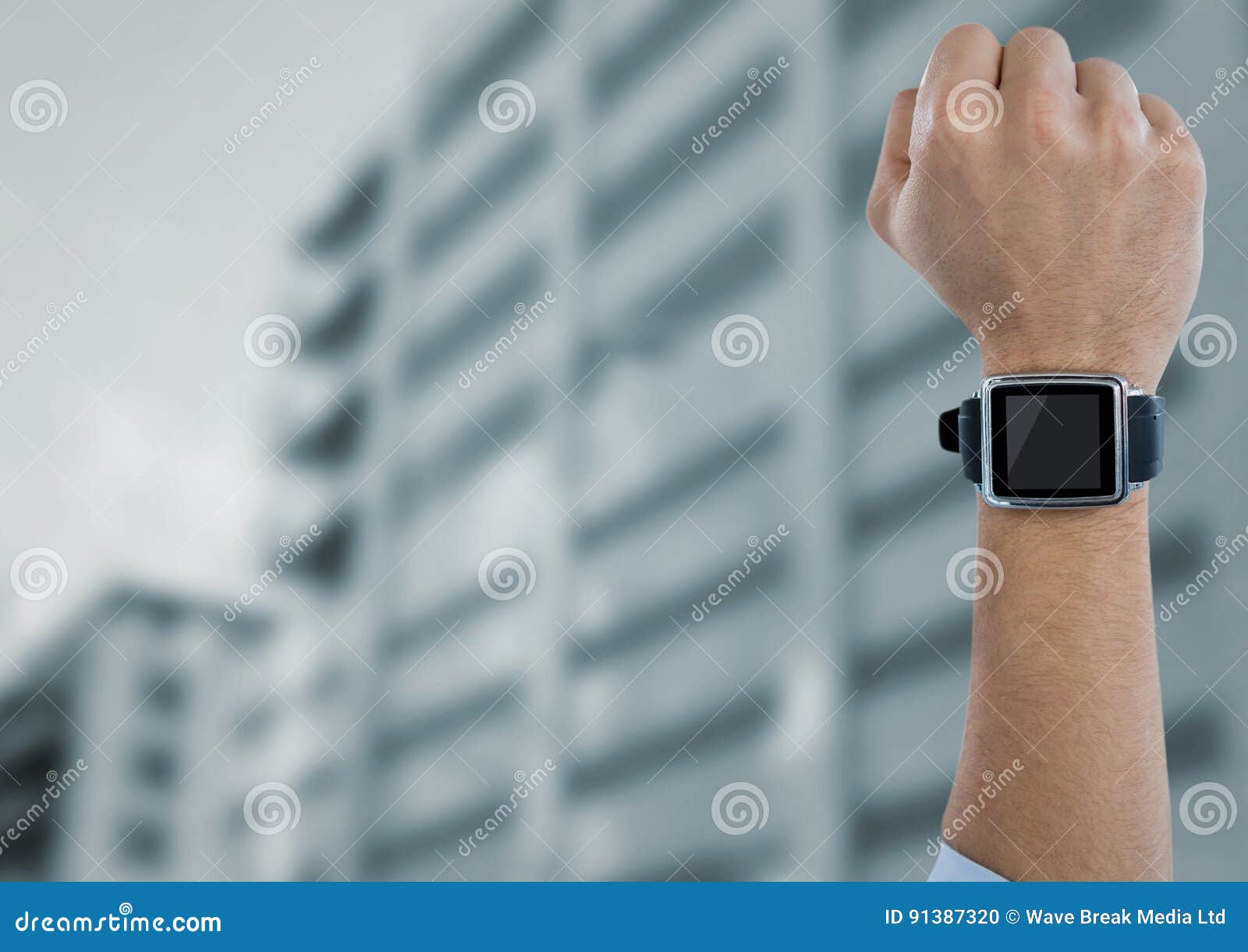 Fist in Air with Watch Against Blurry Building Stock Photo - Image of ...
