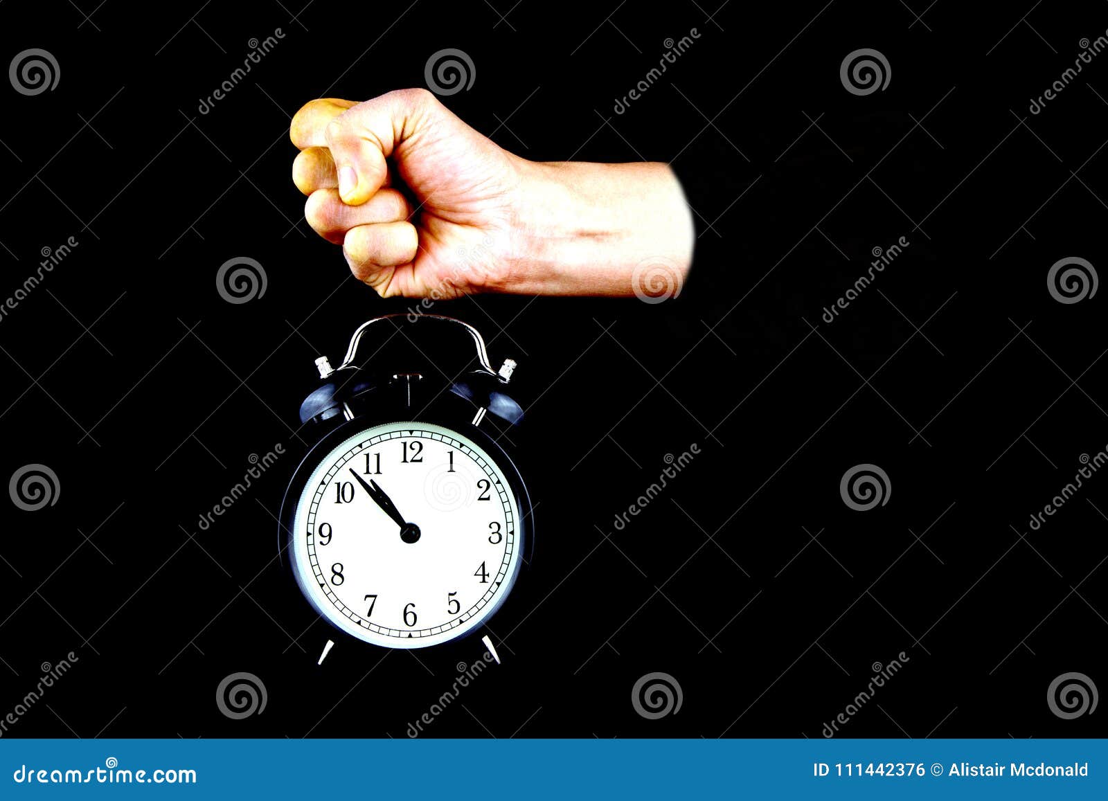 Fist Punching Down on Alarm Clock on Black Background Stock Photo ...