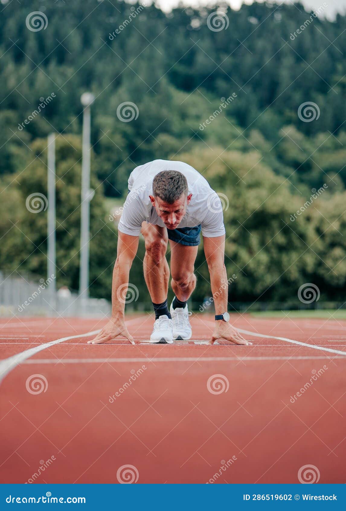 Fit, Active Man Stands on a Marked Start Line, Ready To Begin a Workout ...