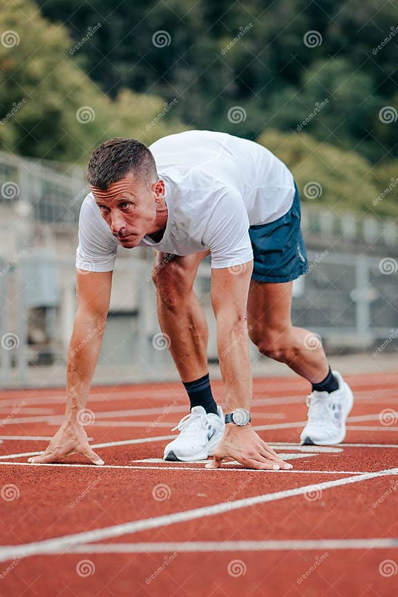 Fit, Active Man Stands on a Marked Start Line, Ready To Begin a Workout ...