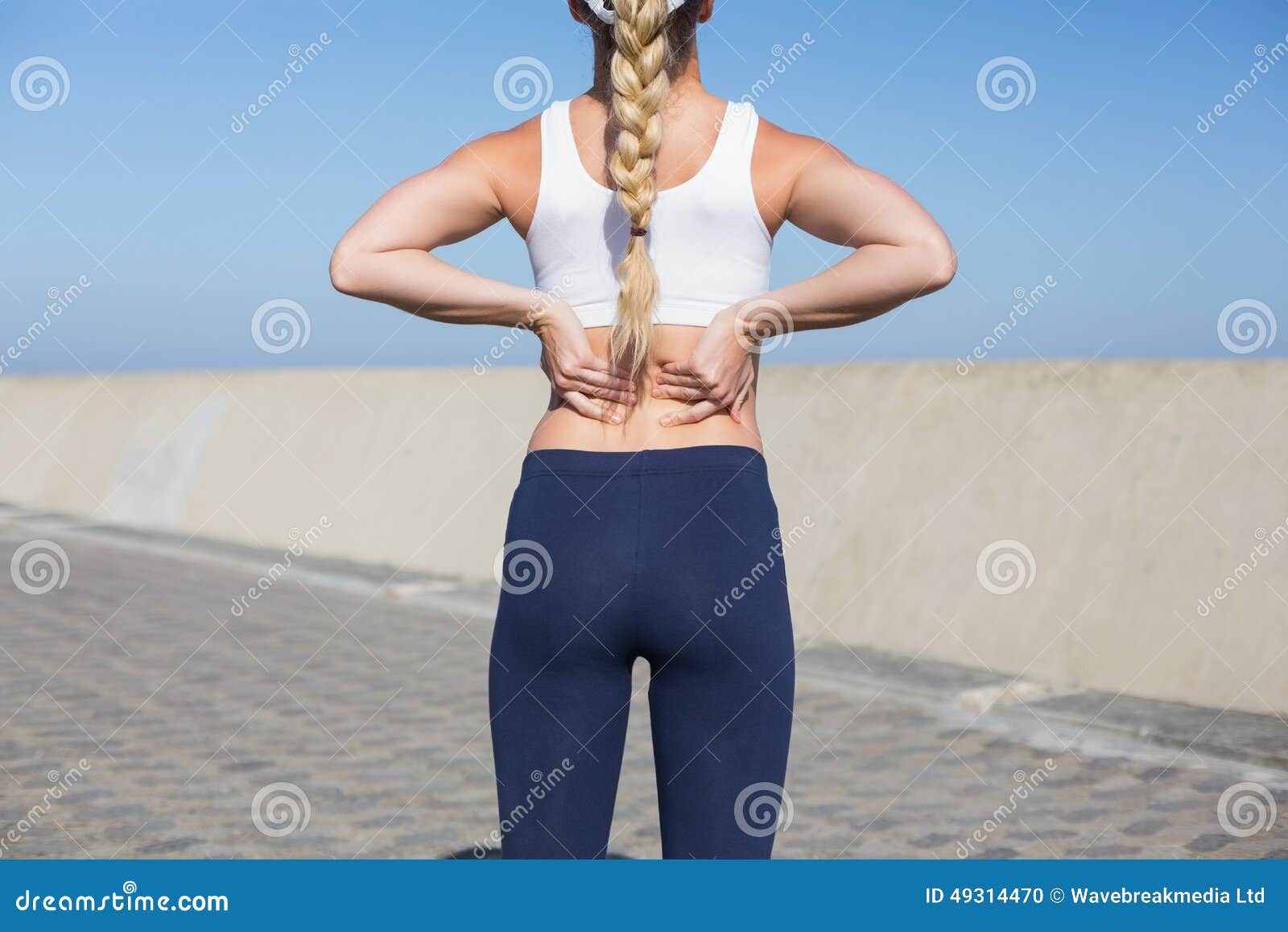 Fit Blonde Touching Her Back on the Pier Stock Photo - Image of ...