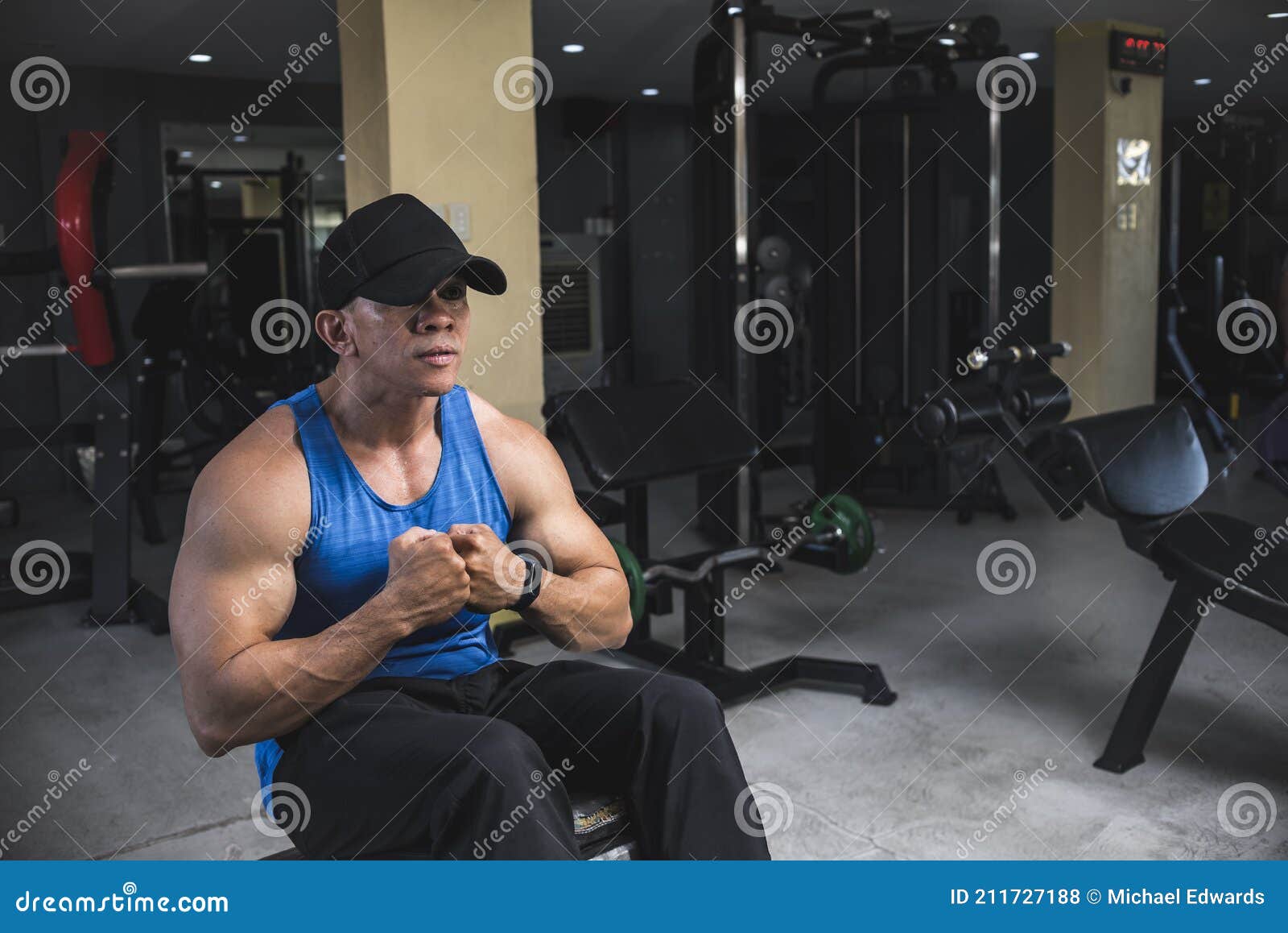 A Fit and Buff Asian Man Working Out at the Gym, Doing Decline Bench ...