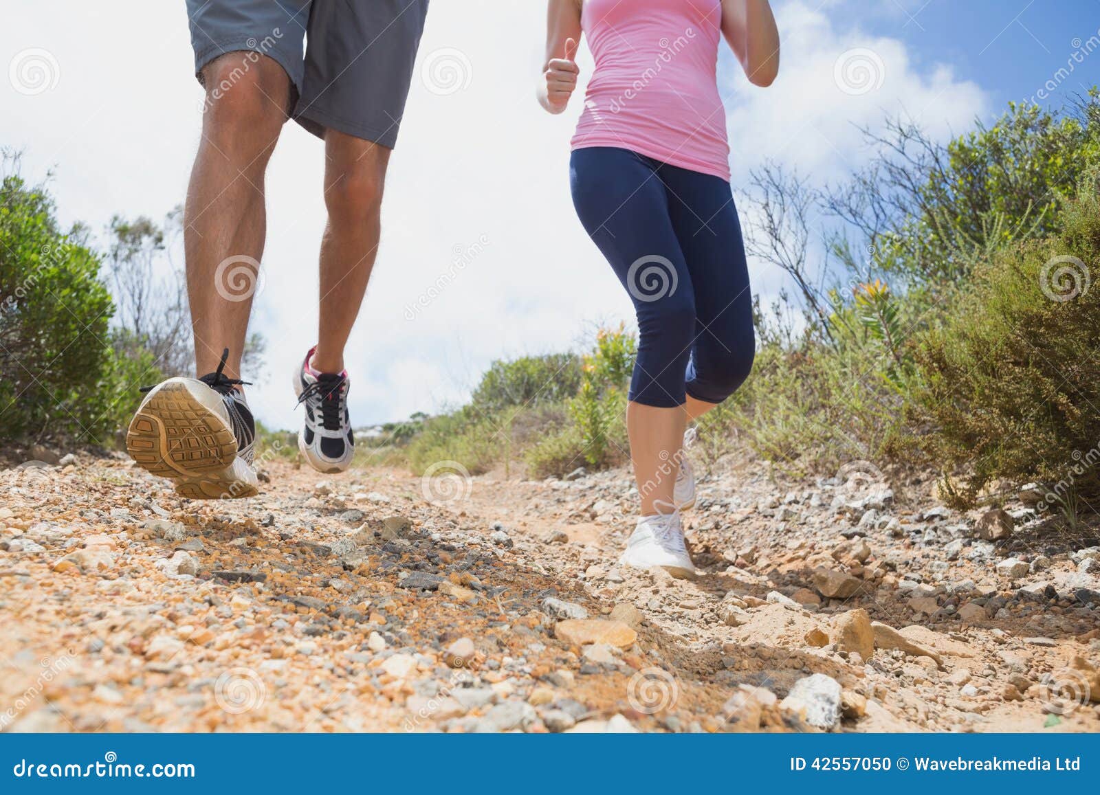 Fit Couple Running Down Mountain Trail Stock Photo - Image of female ...