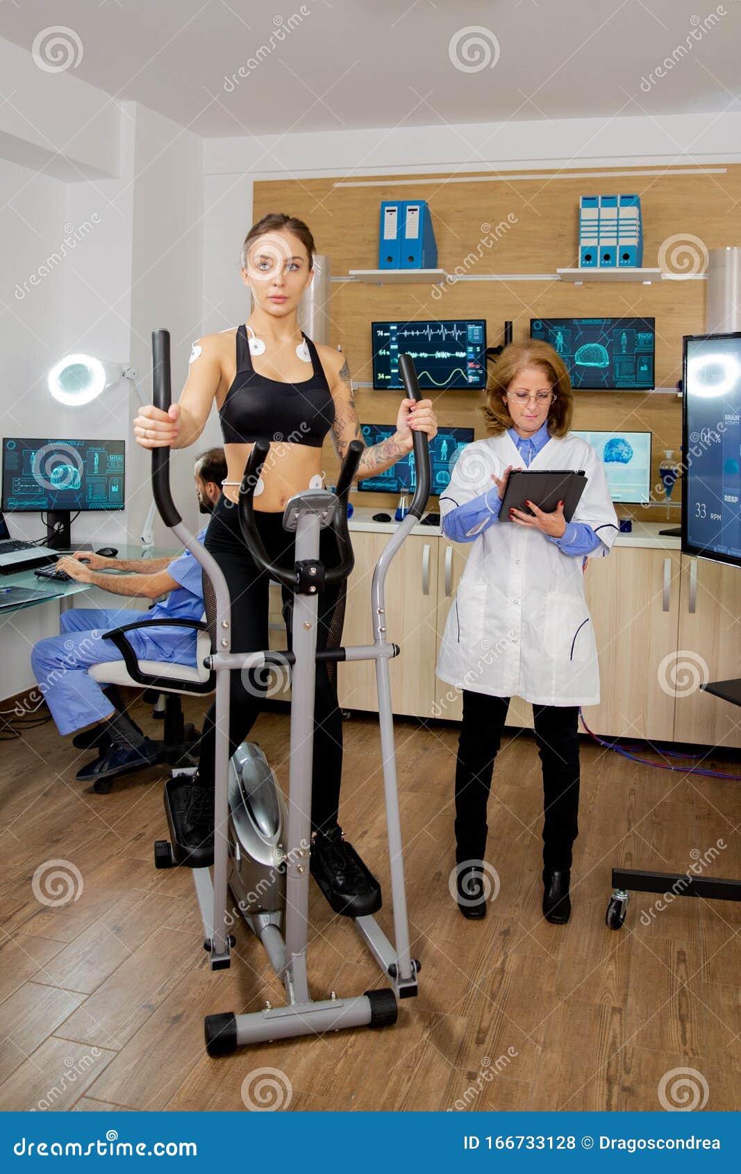 Fit Female Testing Stepper and Doctor Making Notes in Tablet Stock ...