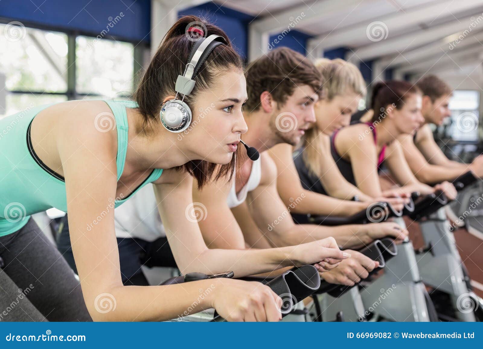Fit Group of People Using Exercise Bike Together Stock Photo - Image of ...