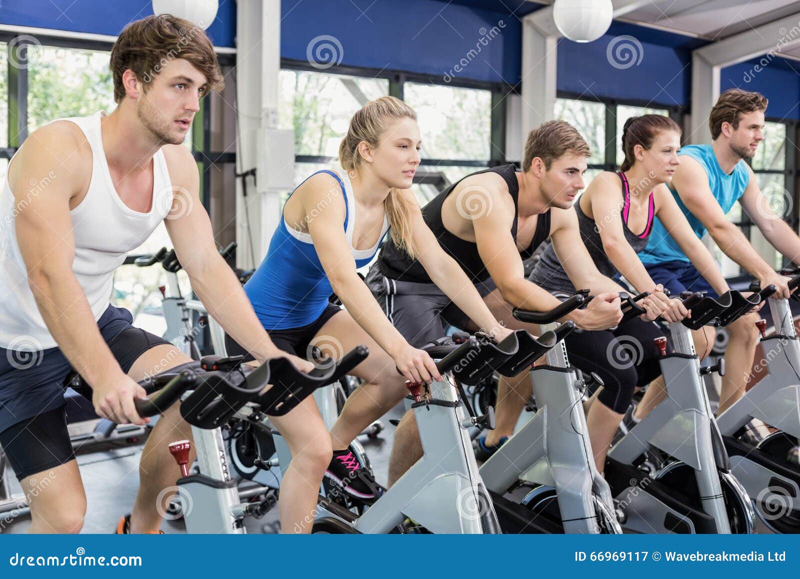 Fit Group of People Using Exercise Bike Together Stock Image - Image of ...
