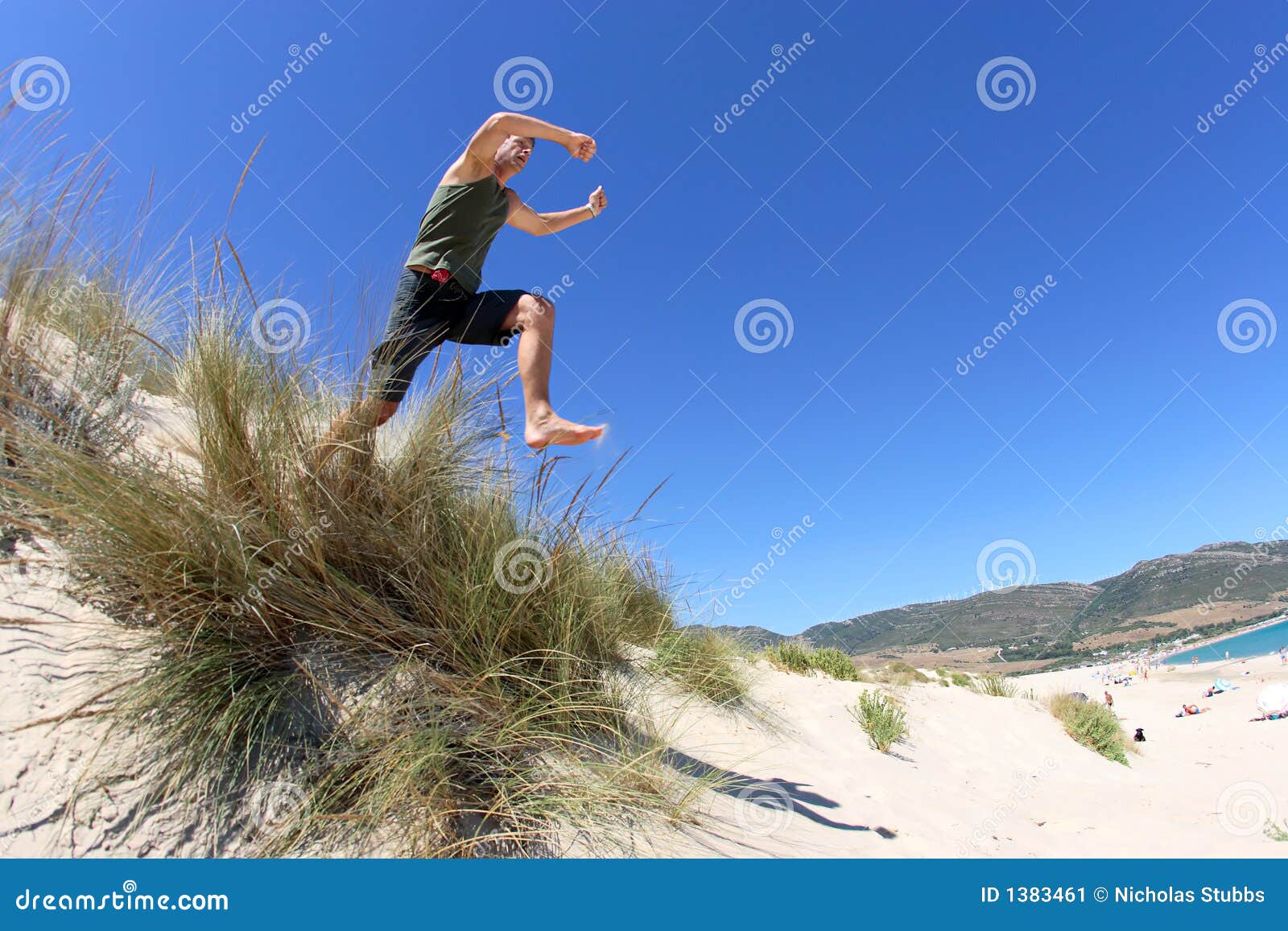 Fit, Healthy Middle Aged Man Leaping Over Sand Dunes Stock Image ...