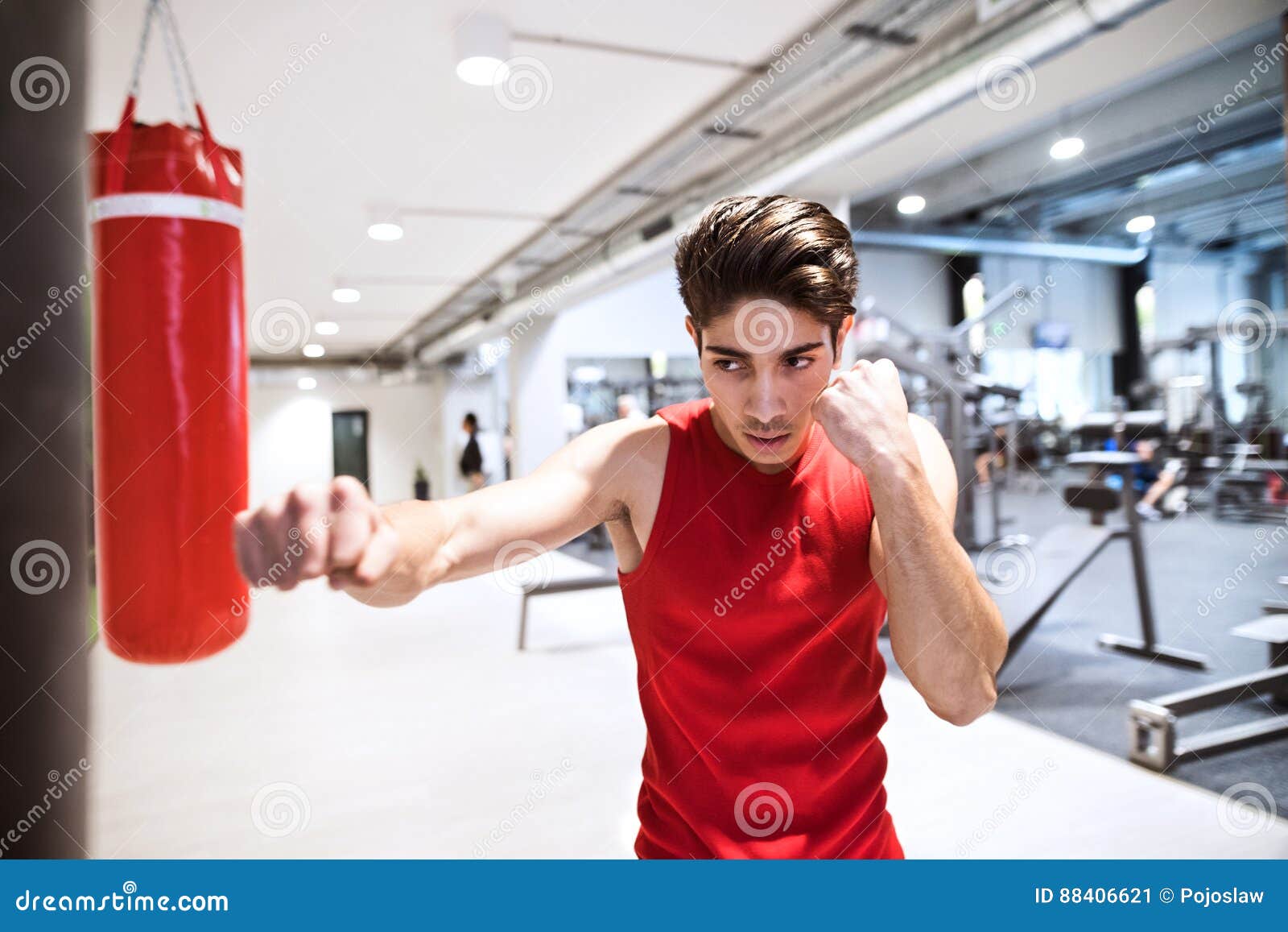 Fit Hispanic Man in Gym Punching Boxing Bag Stock Image - Image of ...