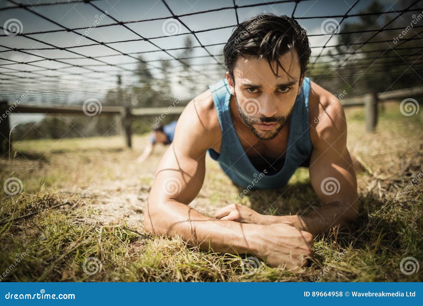 Fit Man Crawling Under the Net during Obstacle Course Stock Photo ...