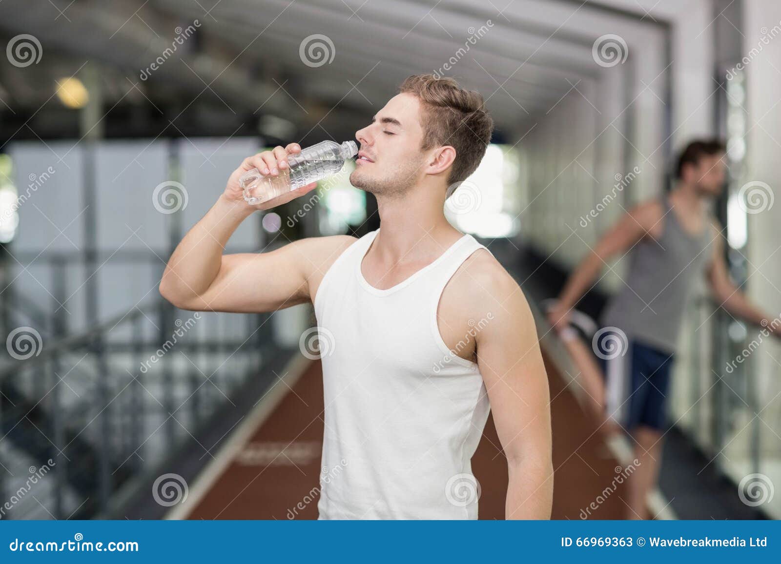 Fit man drinking water stock image. Image of adult, class - 66969363