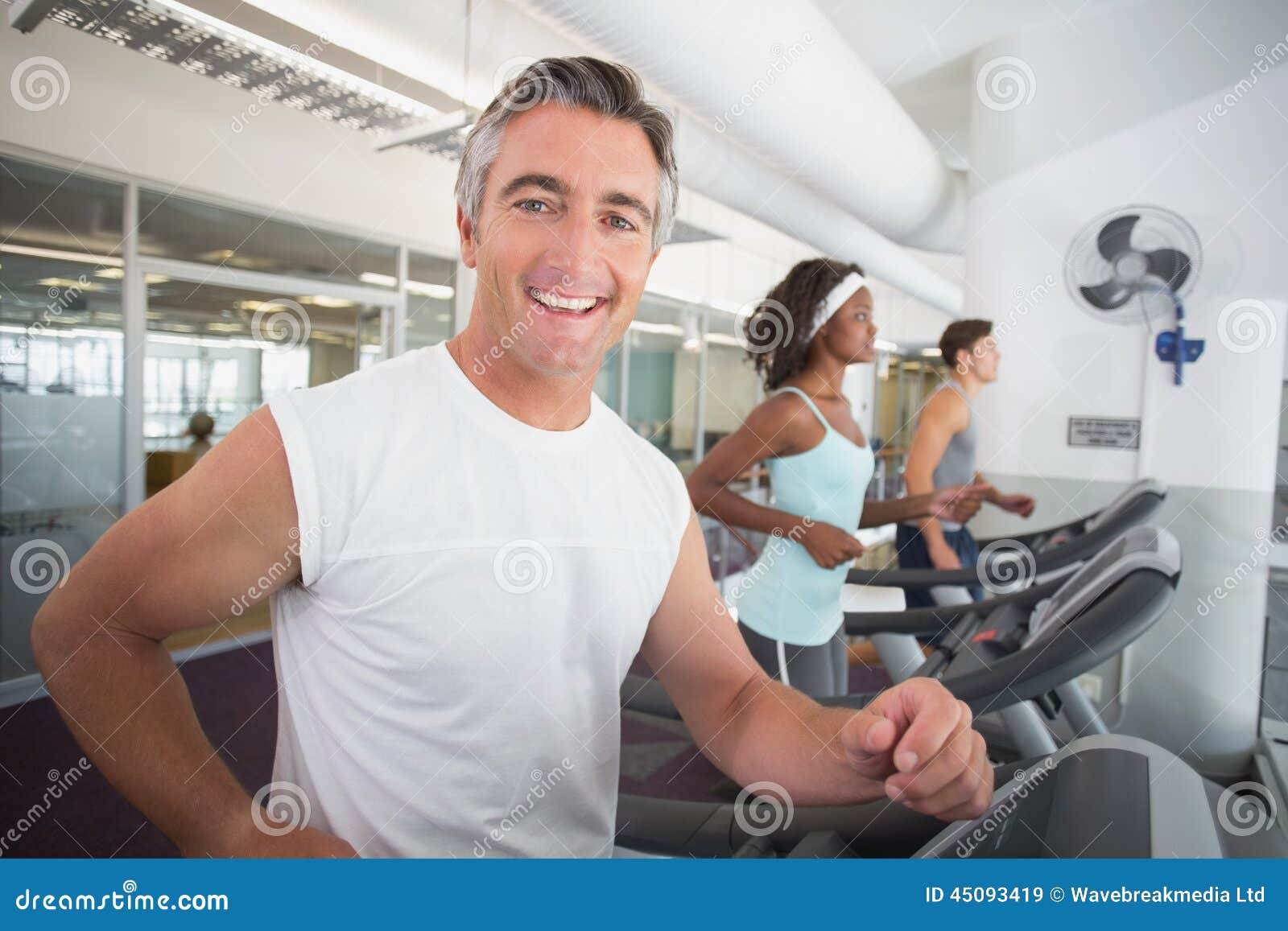 Fit Man Running on Treadmill Smiling at Camera Stock Image - Image of ...