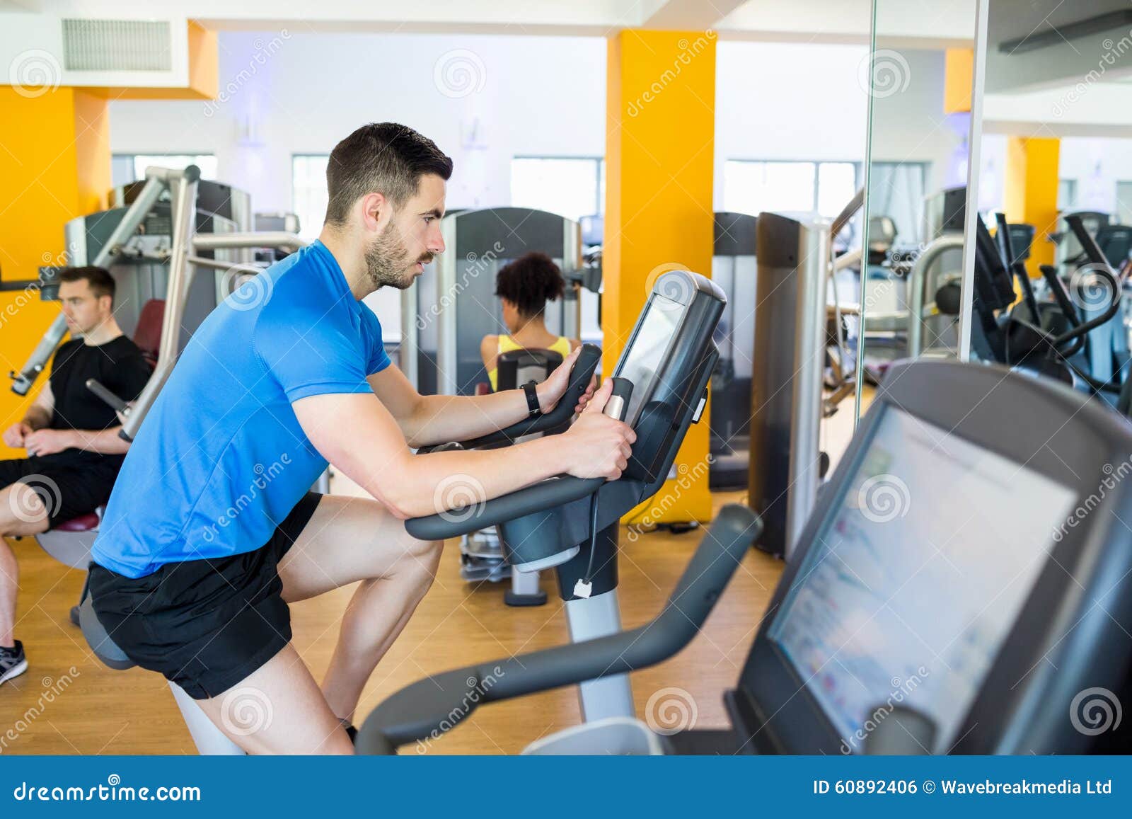 Fit Man Using the Exercise Bike Stock Photo - Image of caucasian ...