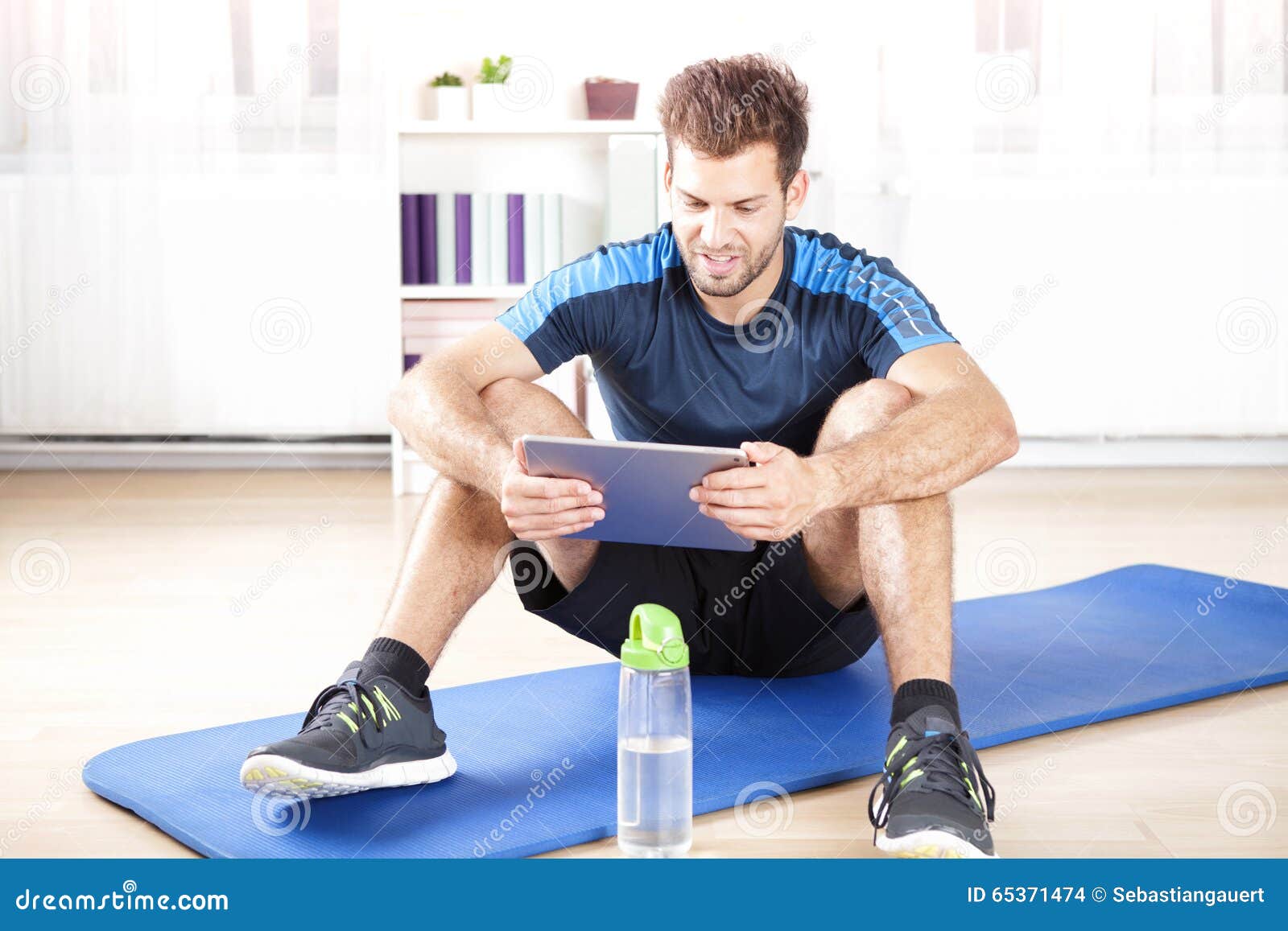 Fit Man Using His Tablet Computer after Exercise Stock Photo - Image of ...