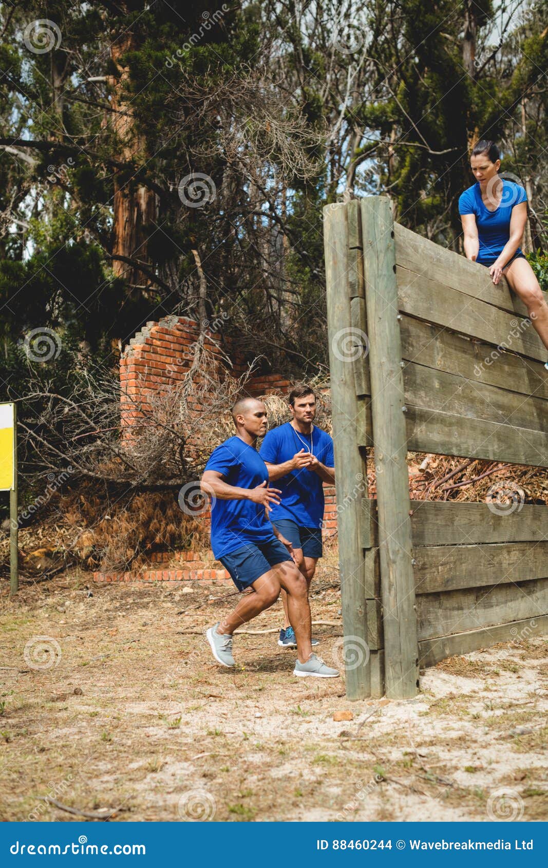 Fit Men Climbing a Wooden Wall during Obstacle Course Stock Photo ...