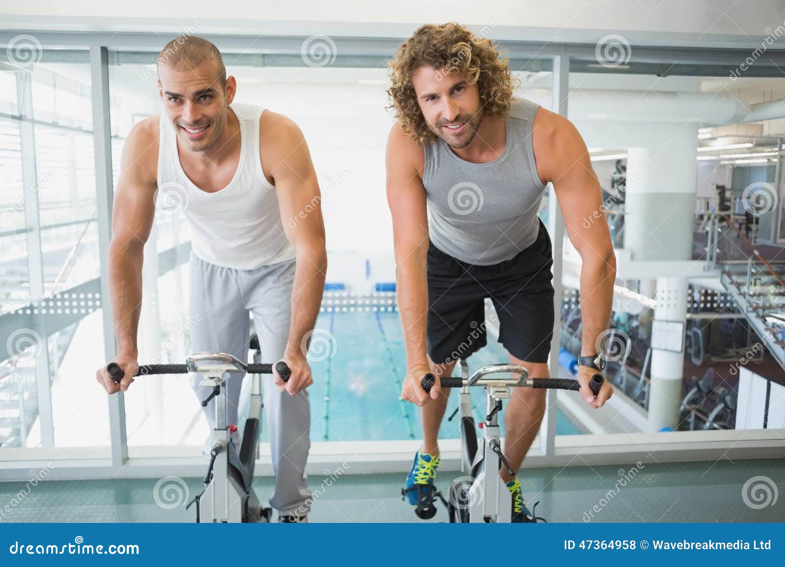 Fit Men Working on Exercise Bikes at Gym Stock Photo - Image of sporty ...