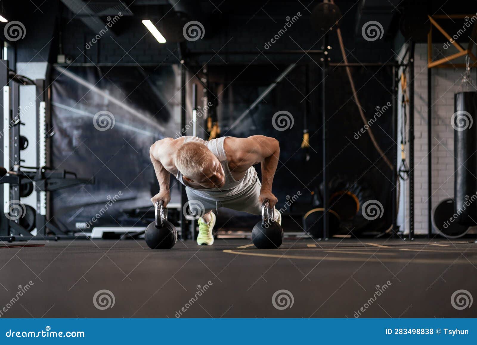 Fit and Muscular Man Doing Horizontal Push-ups on Dumbbells in Gym ...
