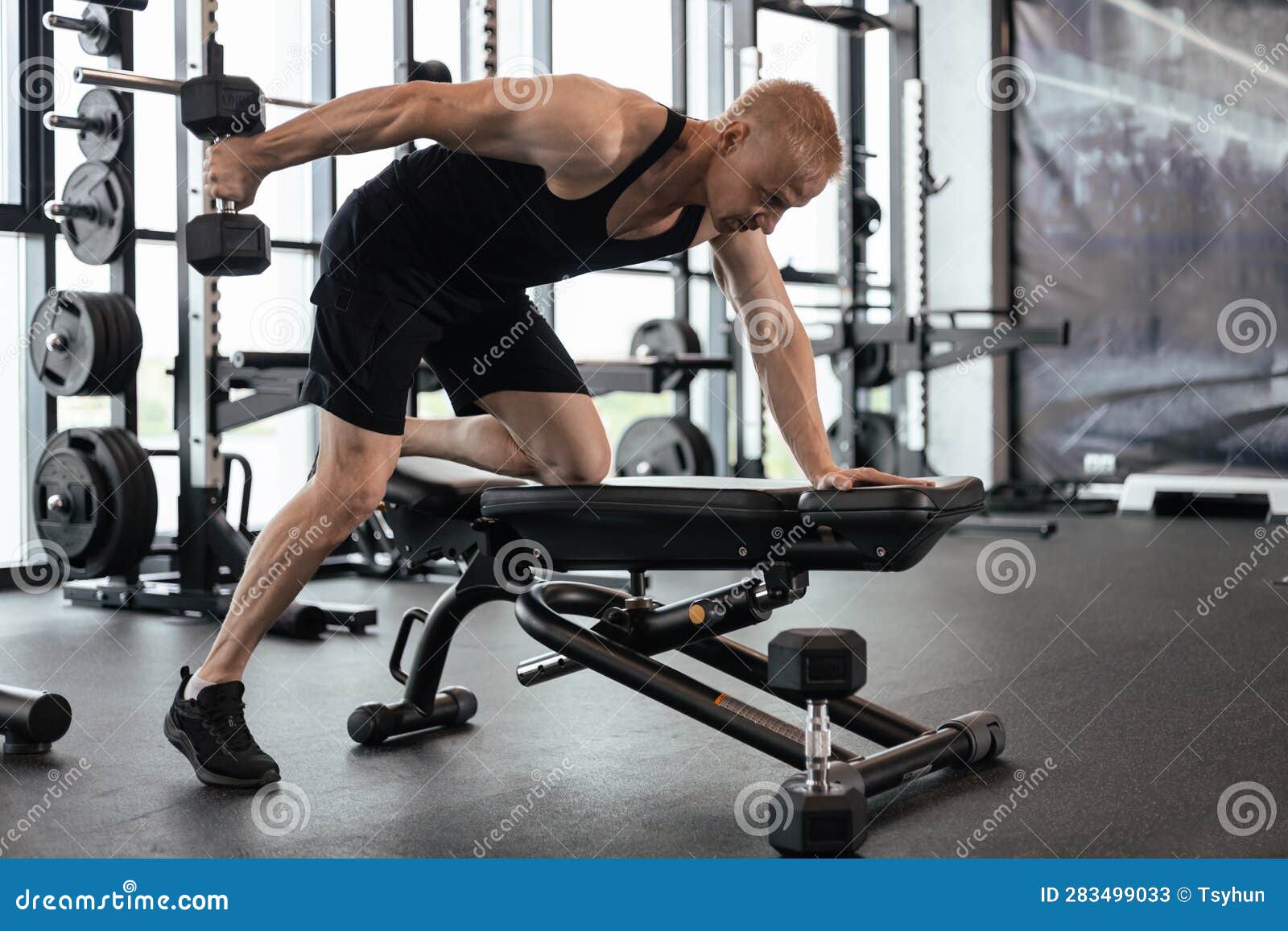 Fit and Muscular Man Trains with Dumbbells. Stock Image - Image of ...