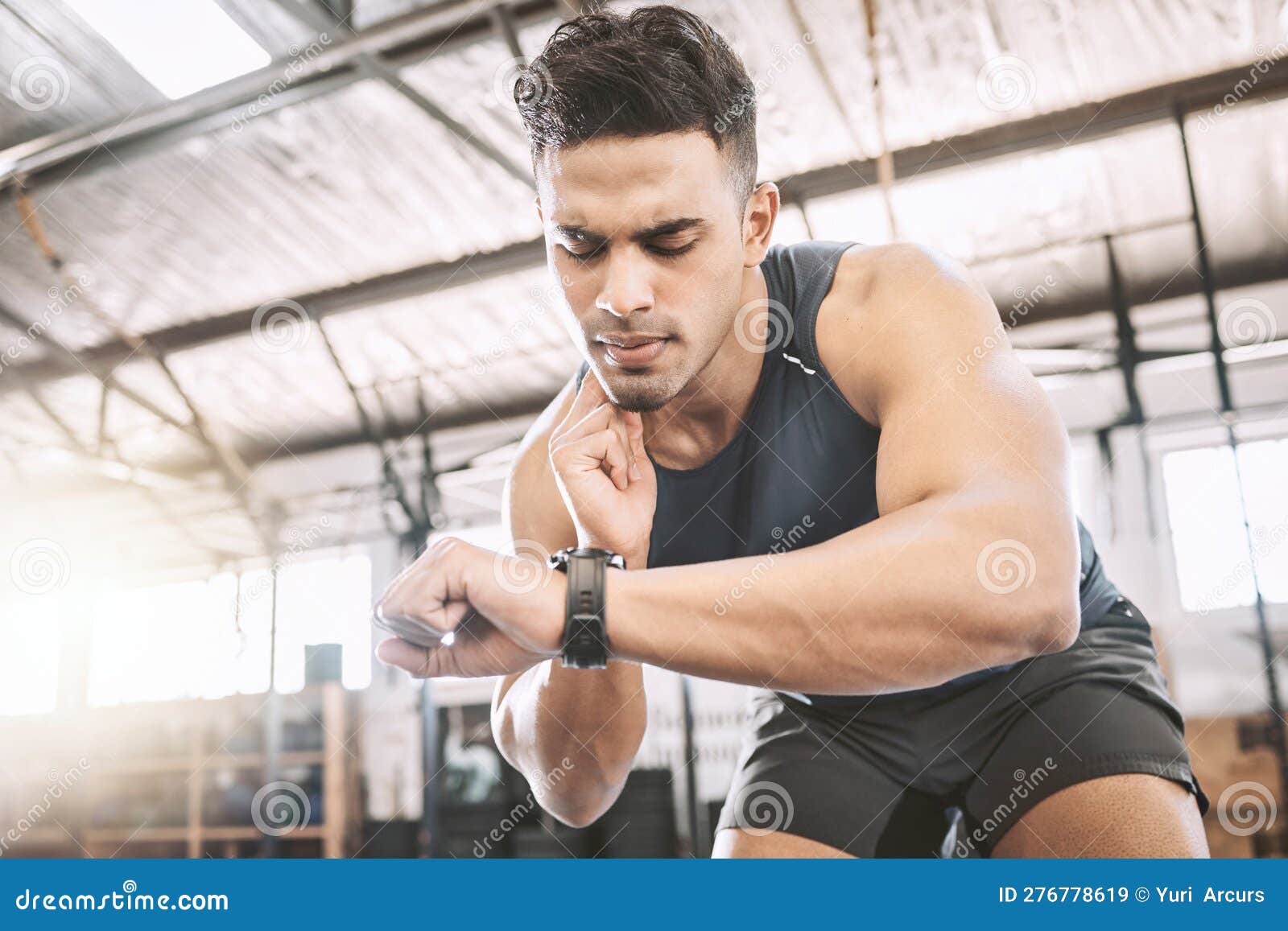 Fit Trainer Checking His Pulse after a Workout. Young Athlete Timing ...