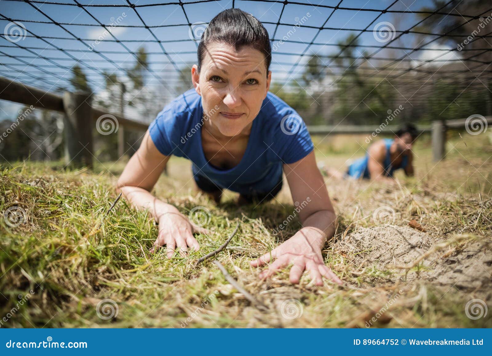 Fit Woman Crawling Under the Net during Obstacle Course Stock Photo ...