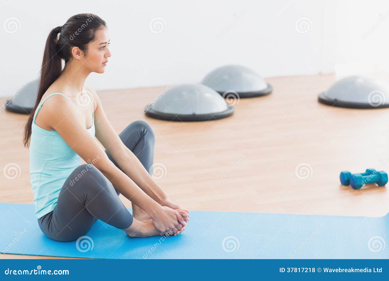 Fit Woman Doing Butterfly Stretch in Exercise Room Stock Photo - Image ...