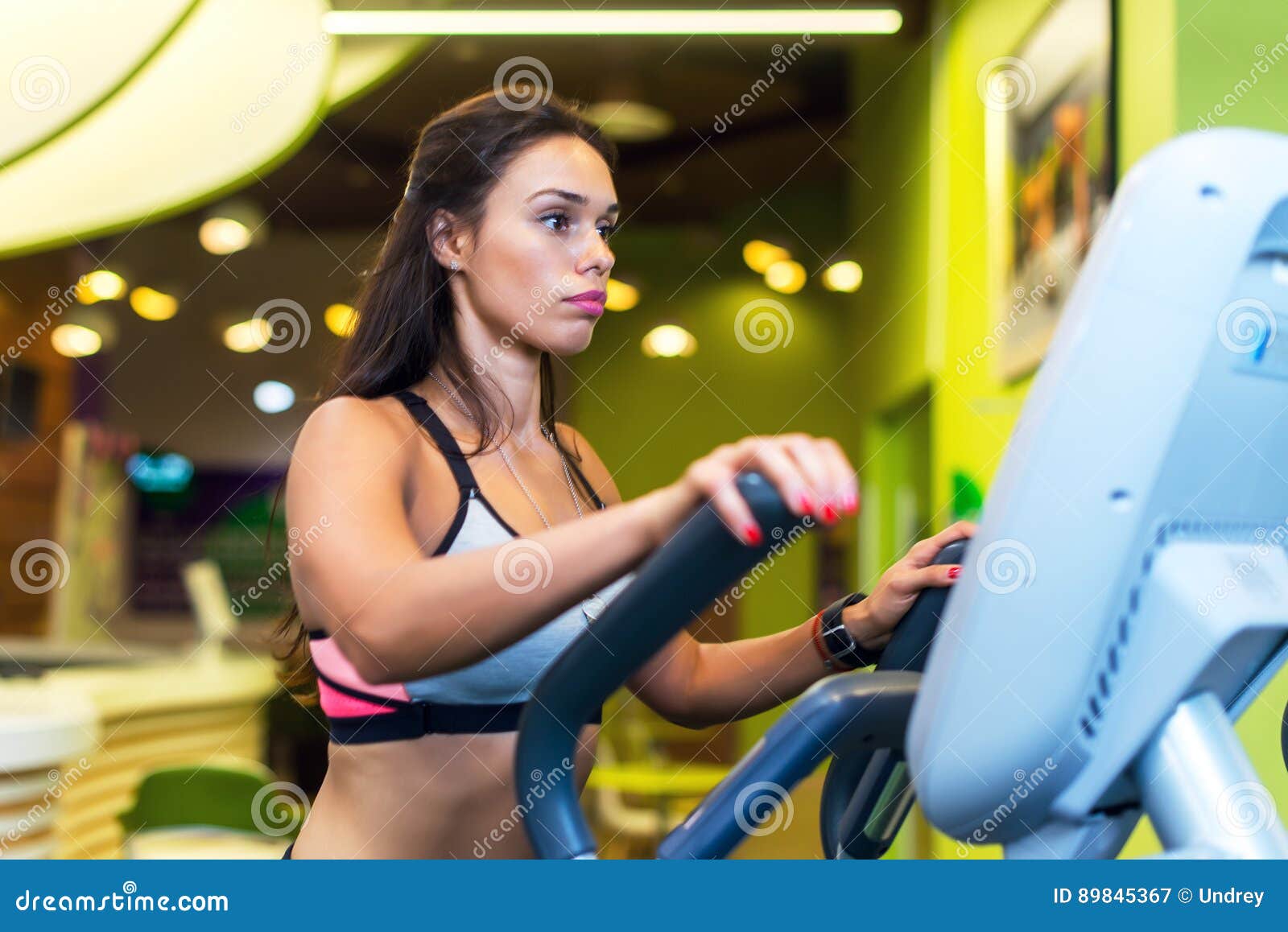 Fit Woman Doing Exercise on a Elliptical Trainer. Stock Image - Image ...