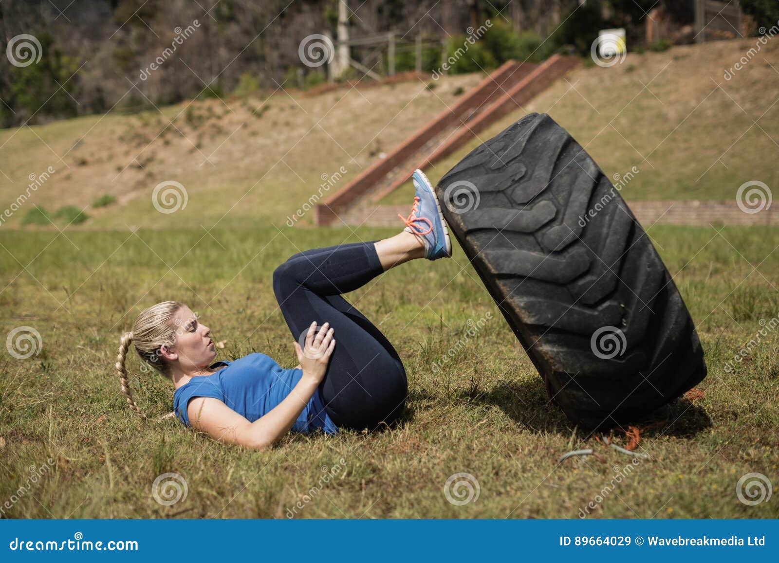 Fit Woman Performing Leg Workout with Tier during Obstacle Course Stock ...