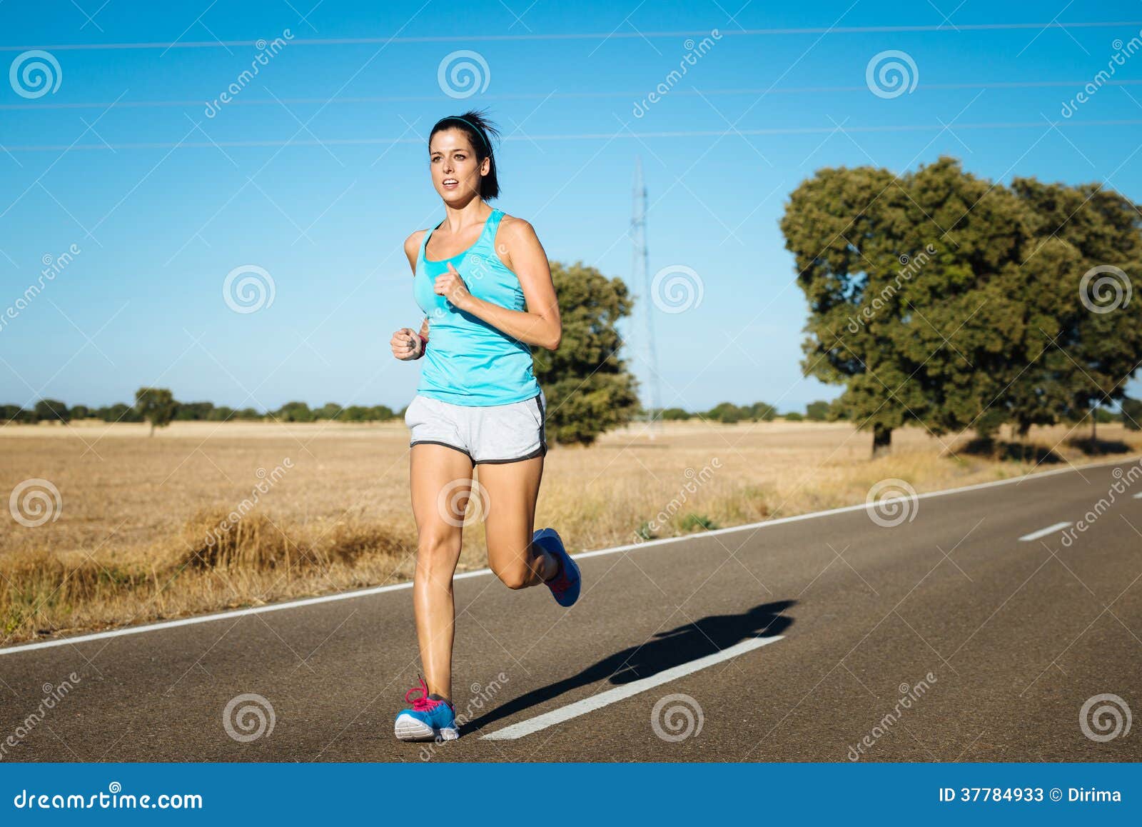 Fit woman running on road stock image. Image of athlete - 37784933